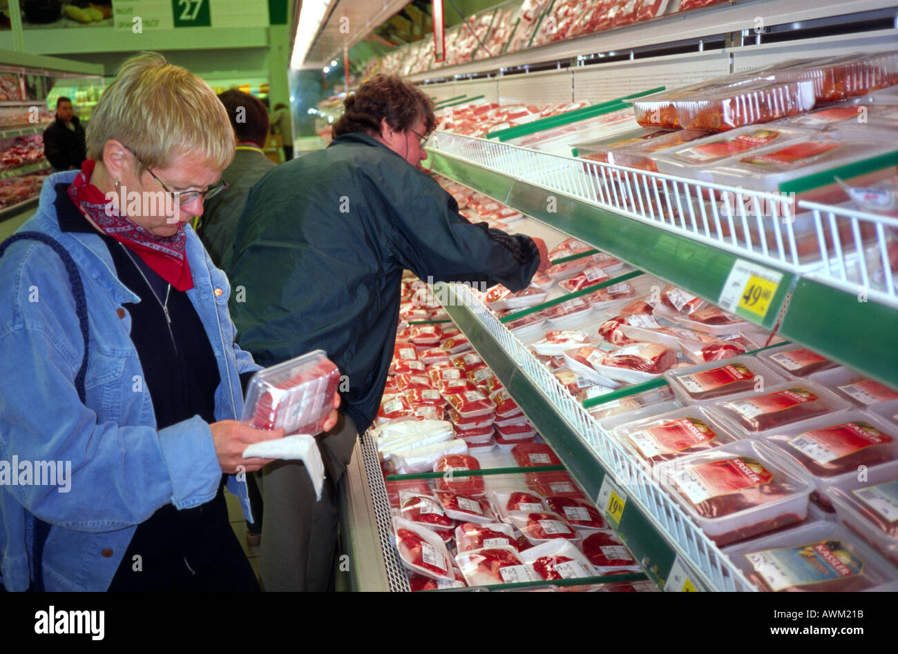 Side view of people buying meats in a supermarket Stock Photo - Alamy