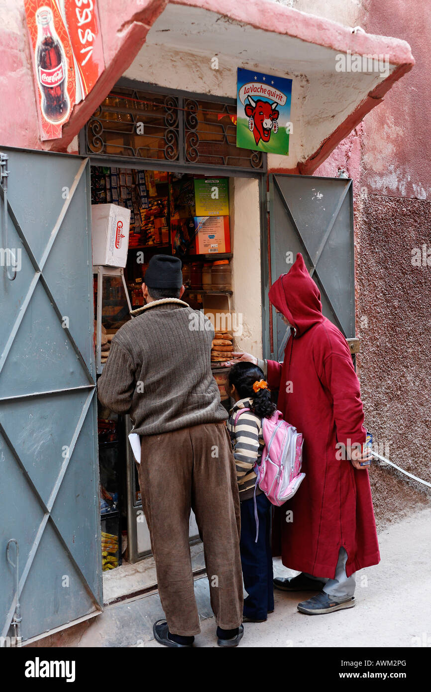 Young girl carrying school backpack standing between two men in front ...