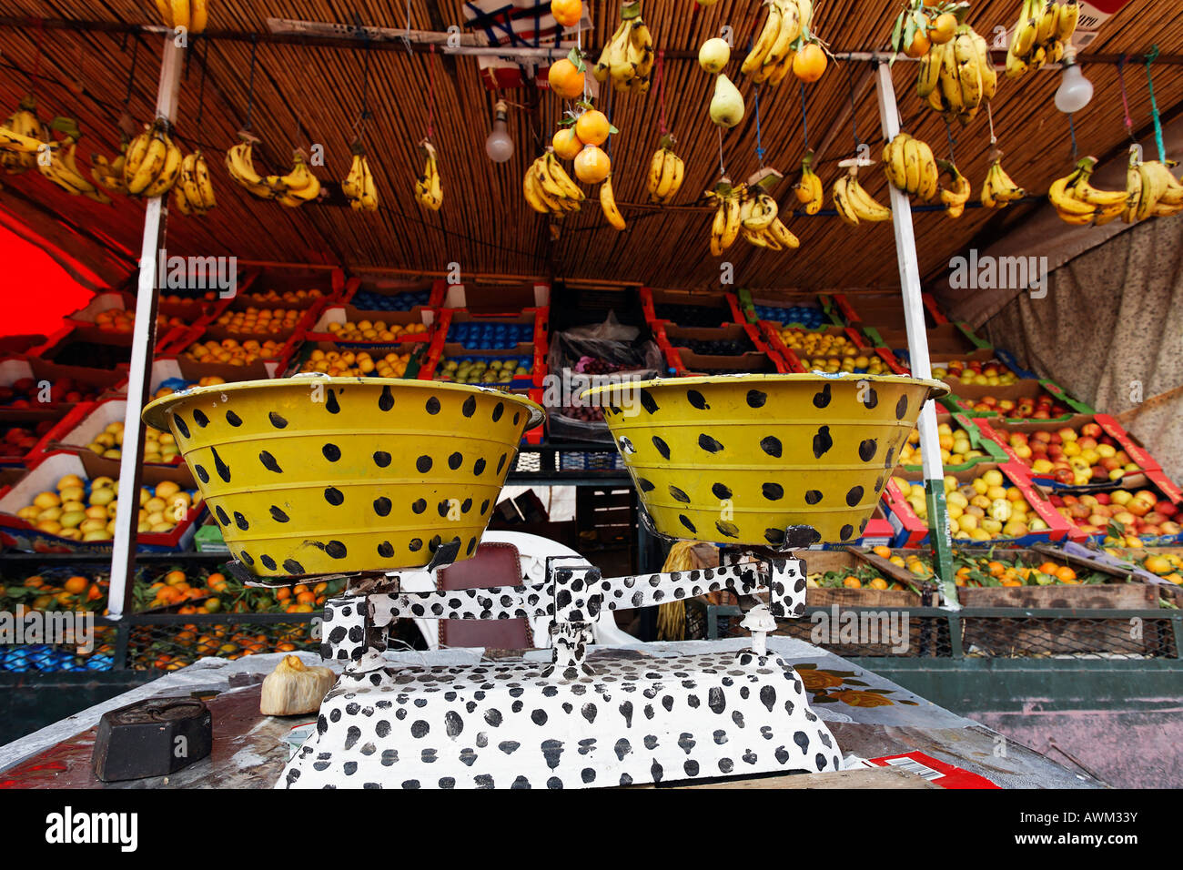 Scales painted with a colourful African pattern in front of a fruit ...
