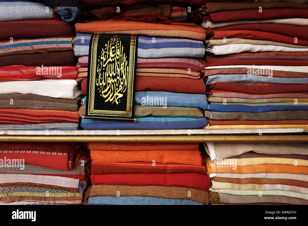 Colourful textiles and a nice Arabic label on a shelf, historic Medina ...