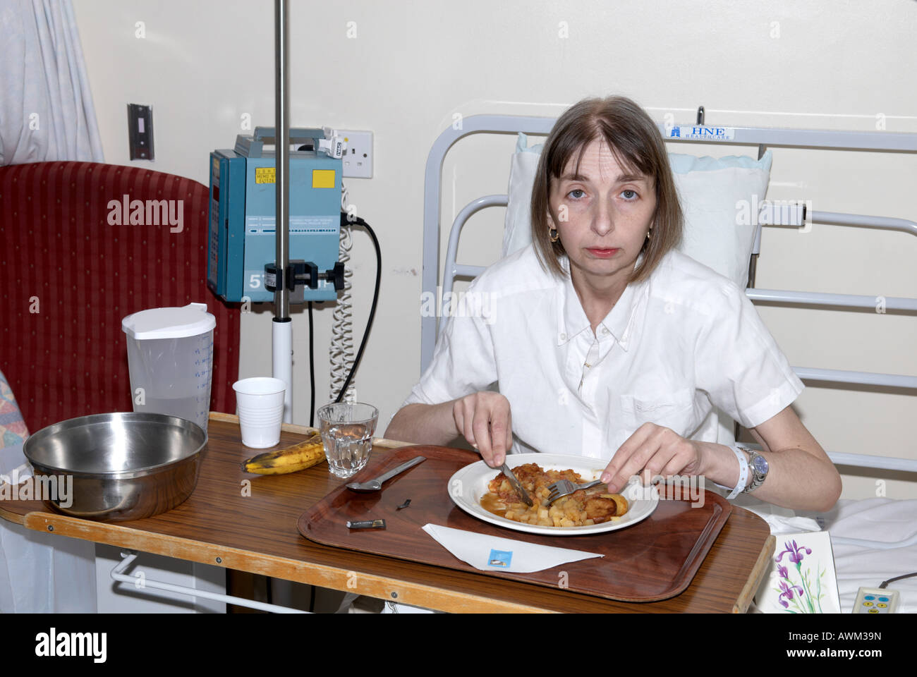 Female patient enjoying her meal in hospital whilst on chemotherapy ...