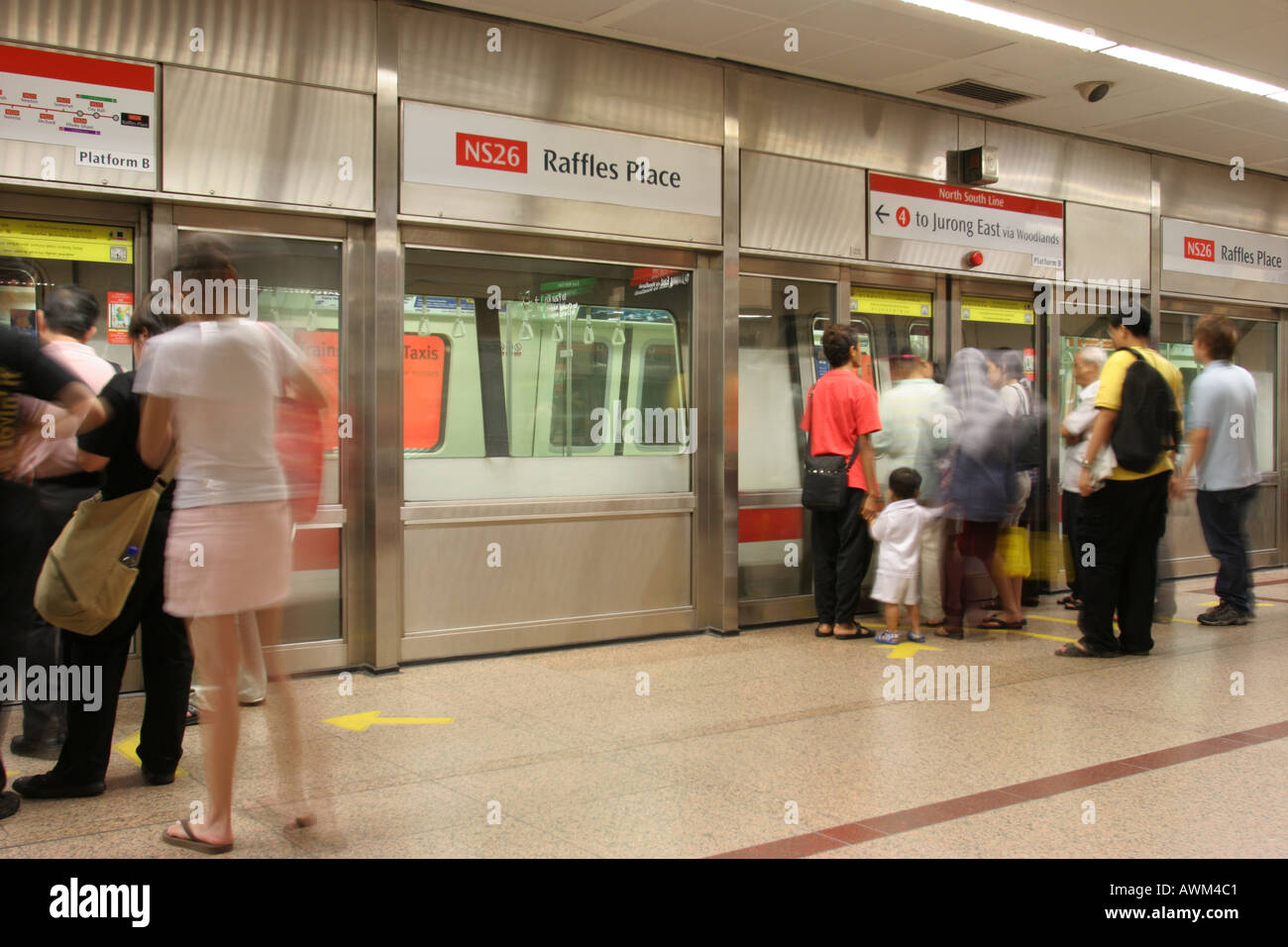 Passengers boarding train at Raffles Place Metro Station Singapore ...