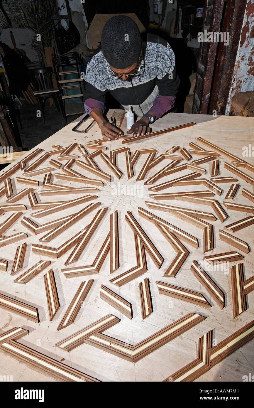 Carpenter making a huge star-shaped ornament, street workshop ...