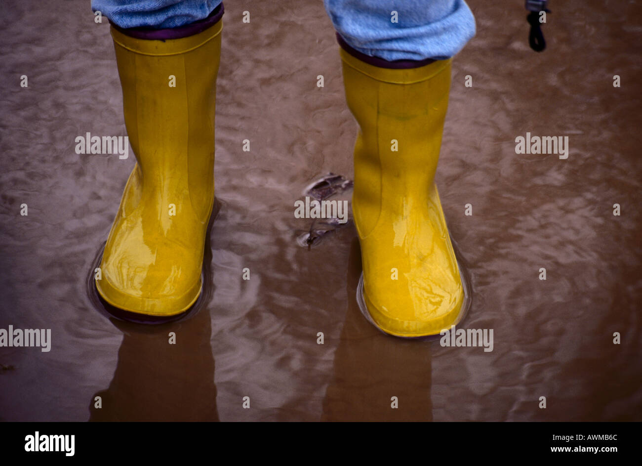 Low section view of person wearing galoshes Stock Photo - Alamy