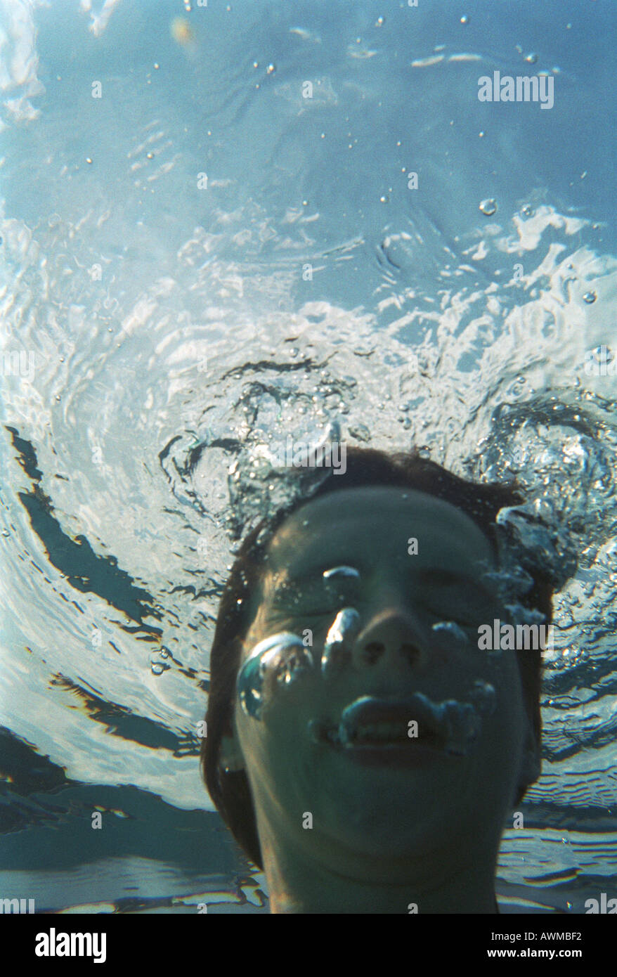 Close-up of teenage girl blowing water bubbles in swimming pool Stock ...