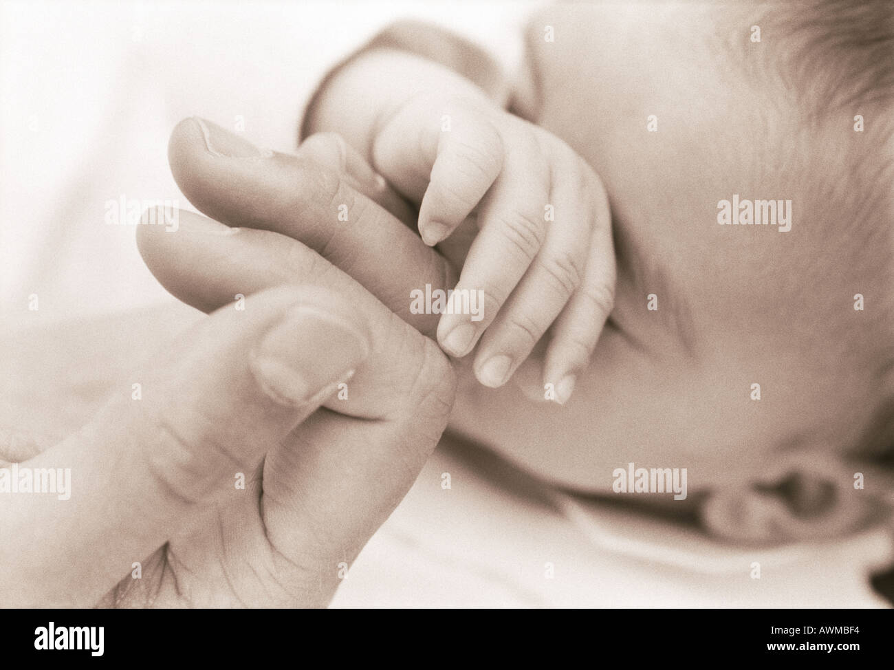 Close-up of a man's hand touching his baby's fingers Stock Photo - Alamy