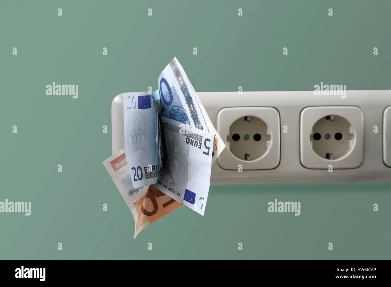 Socket gulping up money Stock Photo - Alamy