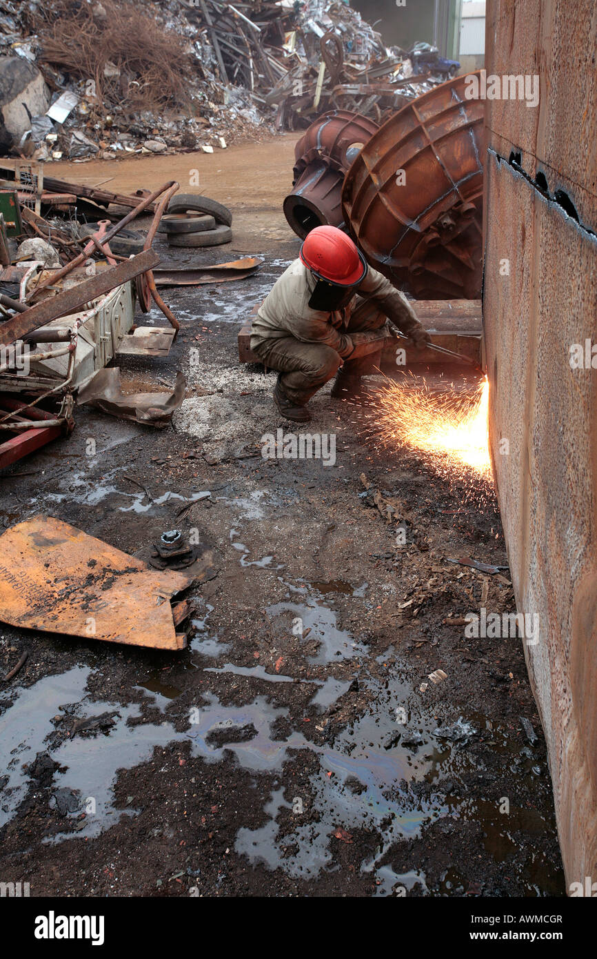 Welder on scrapyard Stock Photo - Alamy