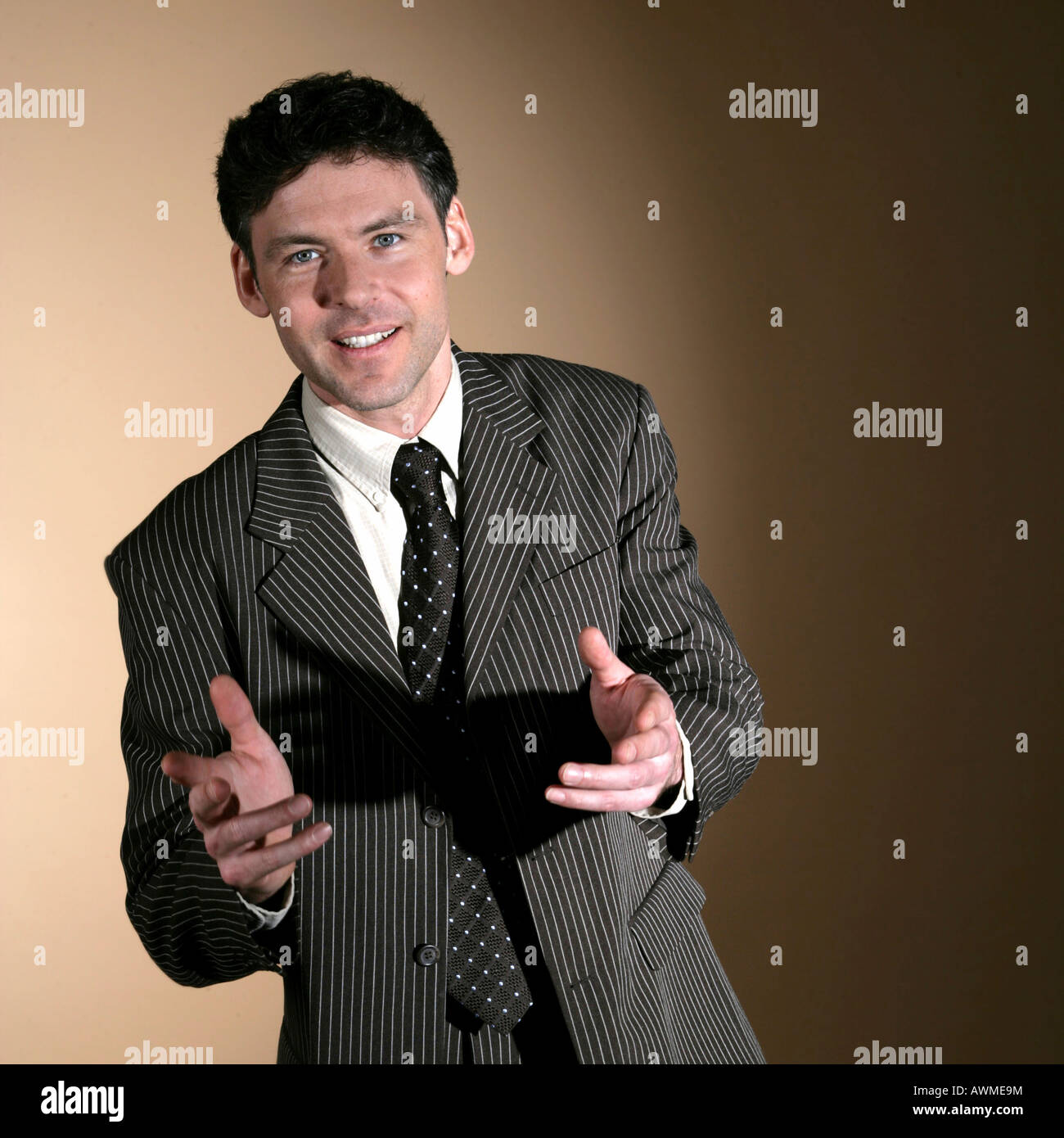 Man wearing suit gesturing with his hands Stock Photo - Alamy