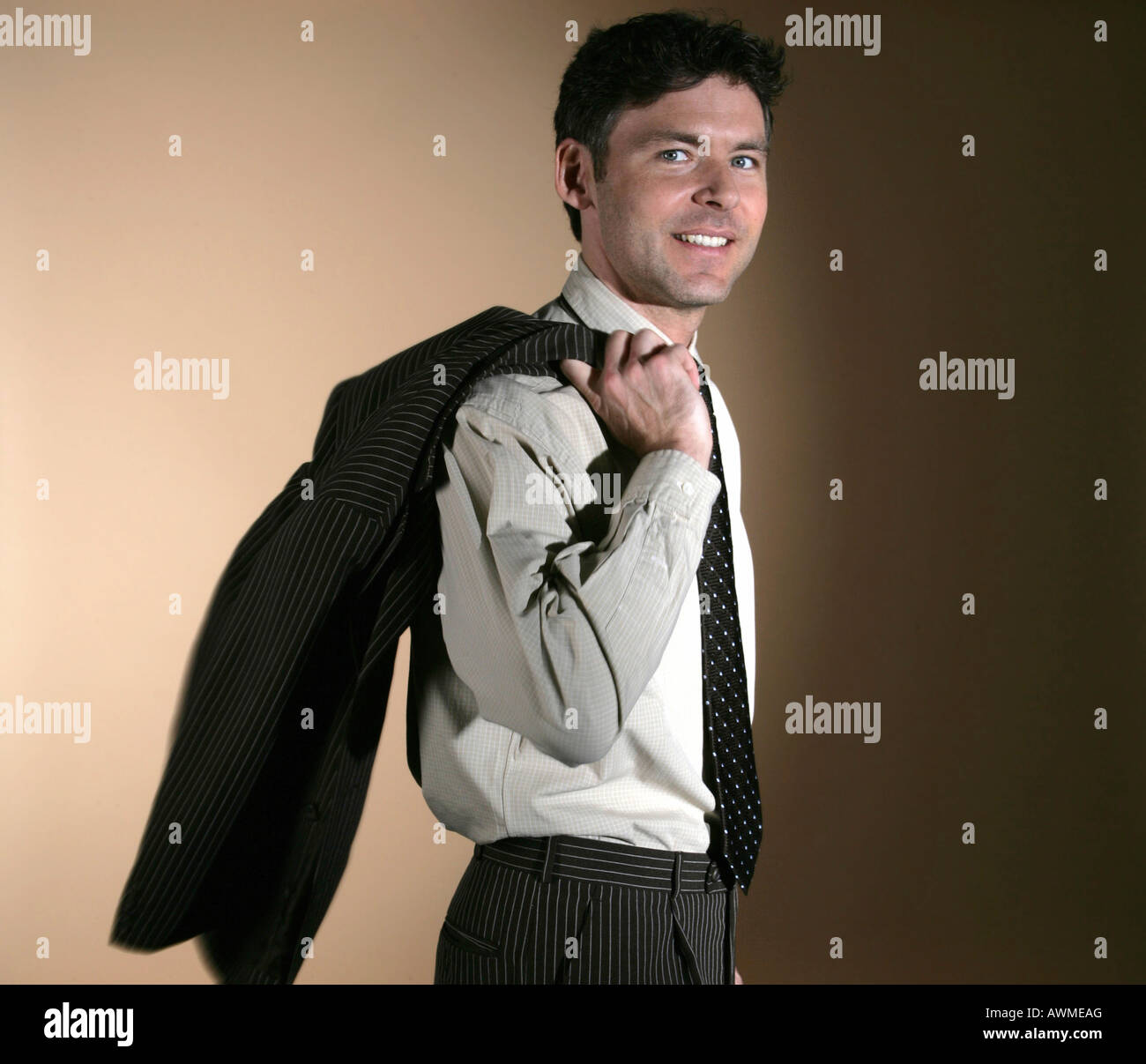 Man wearing suit with his jacket over his shoulder Stock Photo - Alamy
