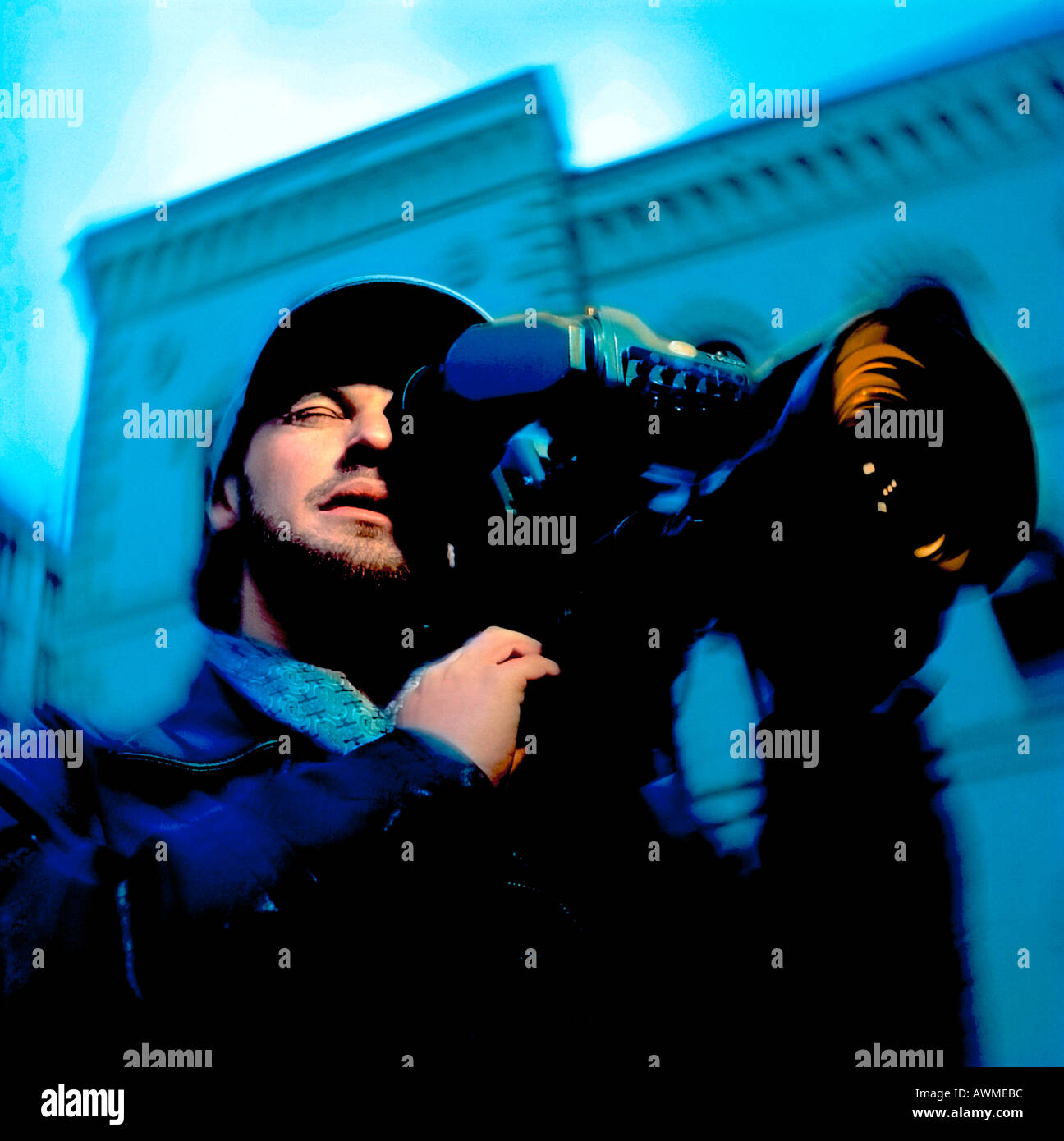 Male press tv reporter filming with camera Stock Photo - Alamy