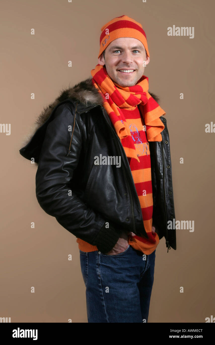 Young man wearing a wool cap and scarf Stock Photo - Alamy