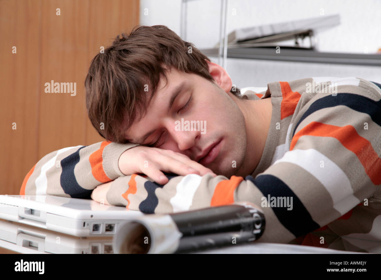 Young man sleeping on desk Stock Photo - Alamy