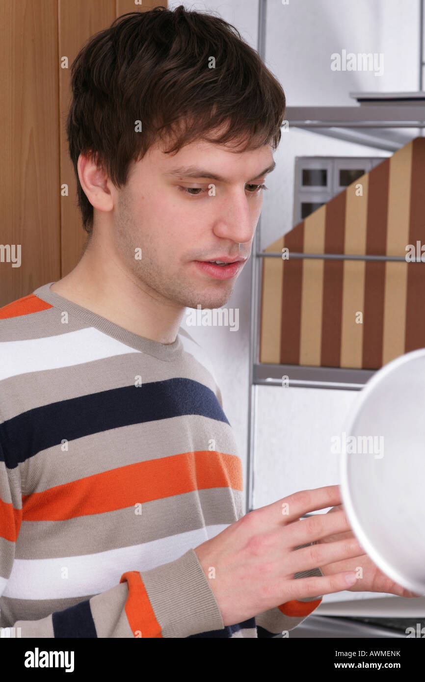 Young man concentrating on work at a desk Stock Photo - Alamy