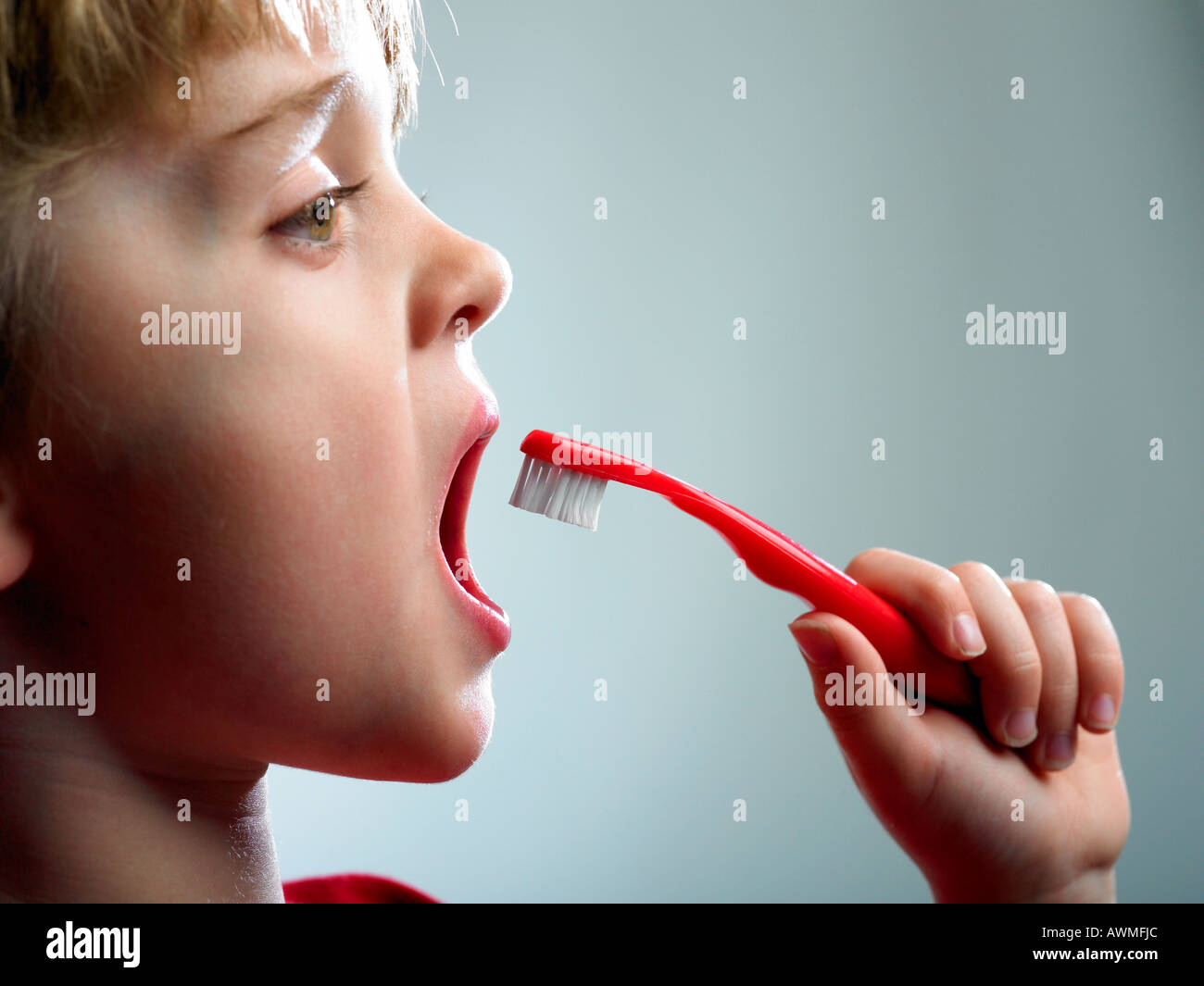child about to brush his teeth with red toothbrush Stock Photo - Alamy