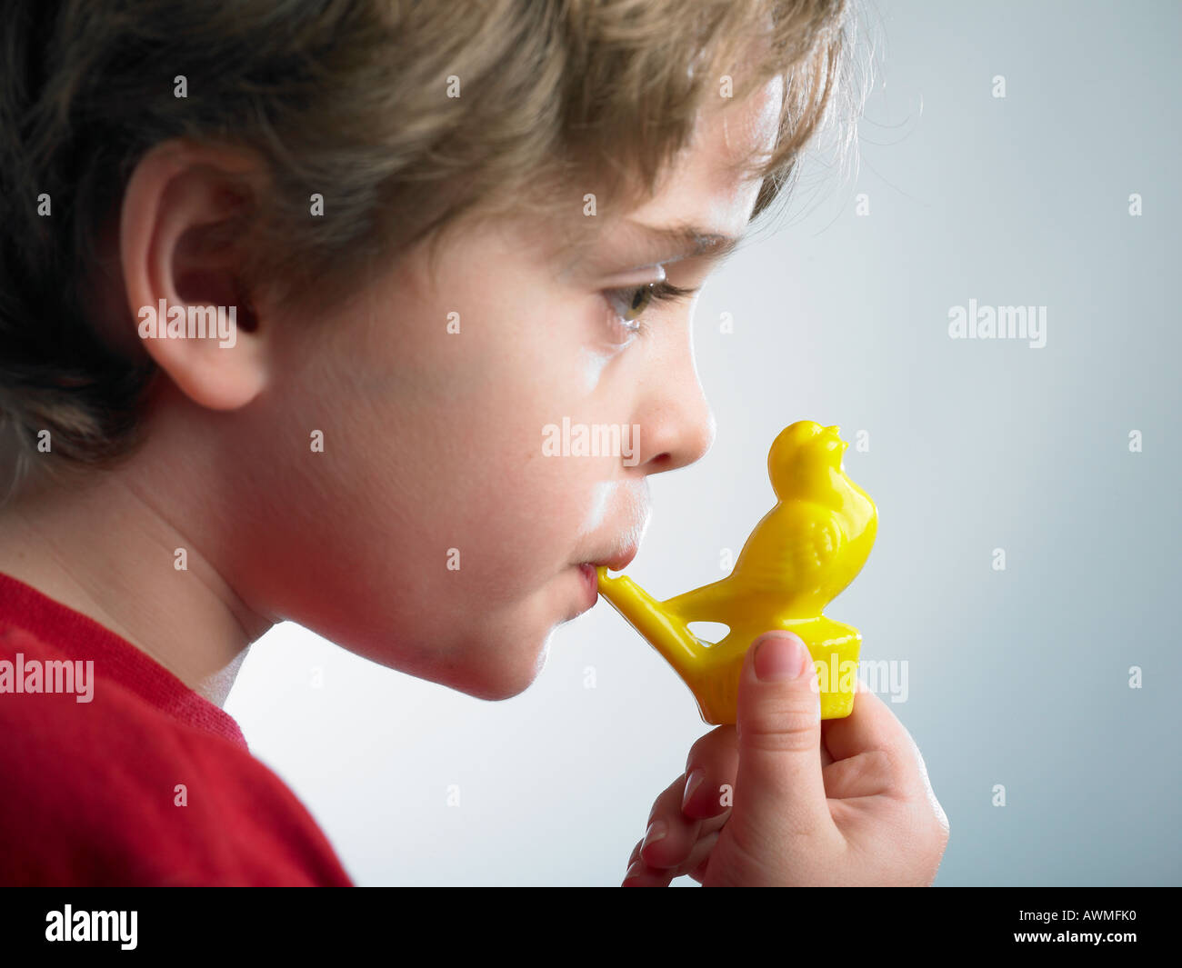 boy blowing birdy whistle Stock Photo - Alamy