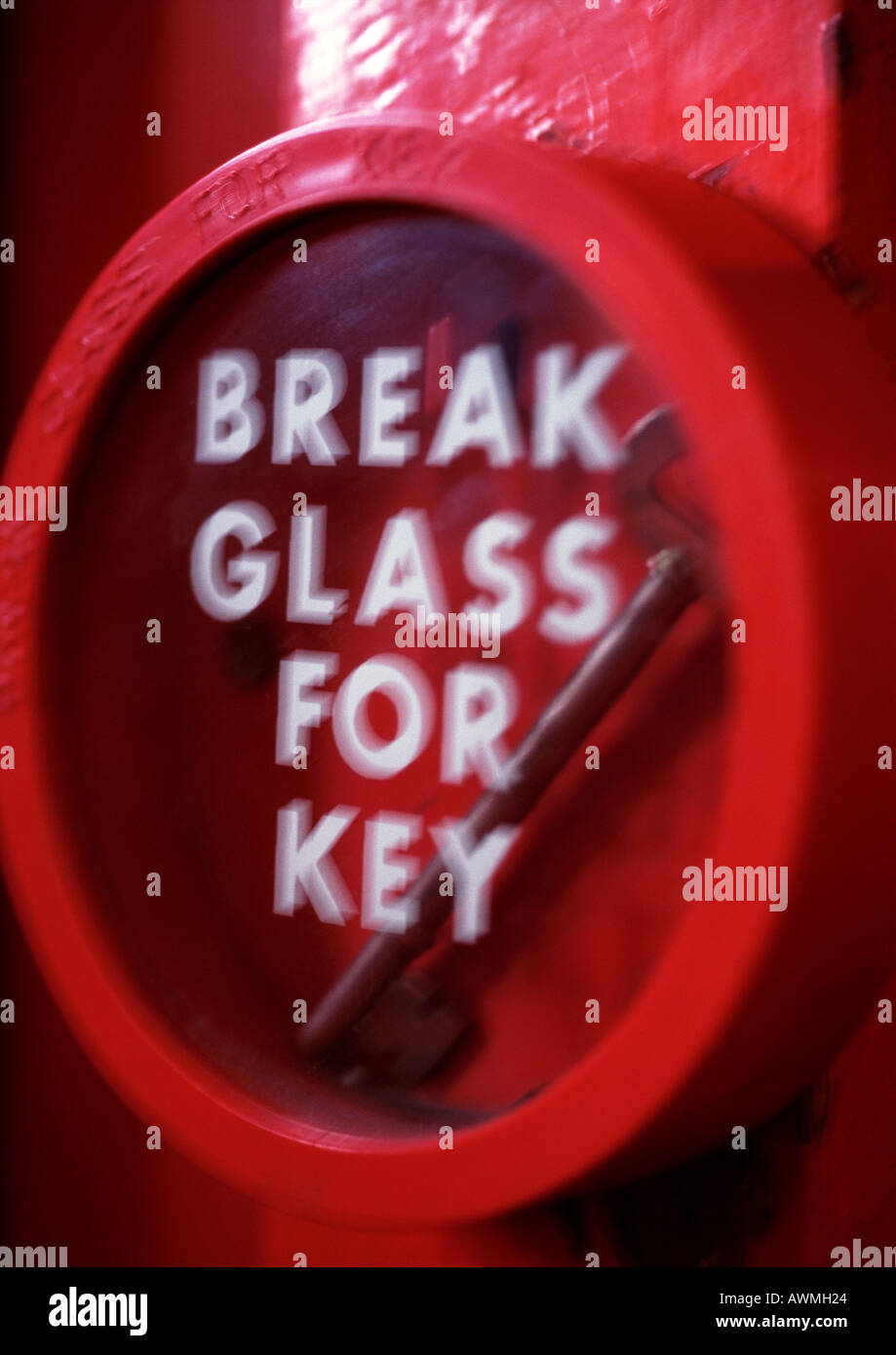 Key behind glass with "break glass for key" text Stock Photo - Alamy