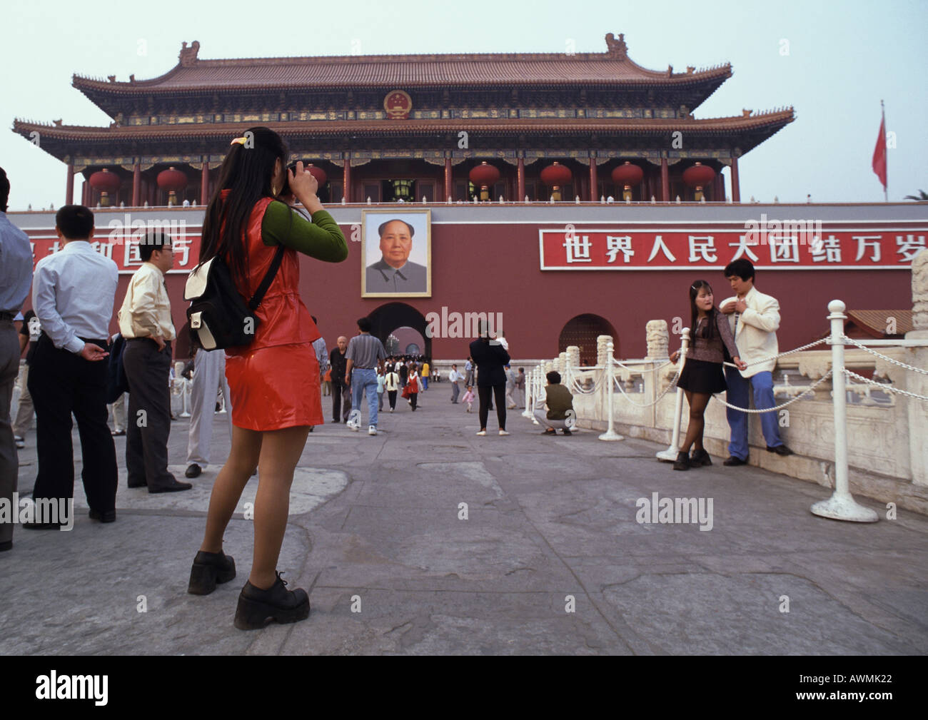 China, Beijing, woman taking photograph of gate leading to the ...
