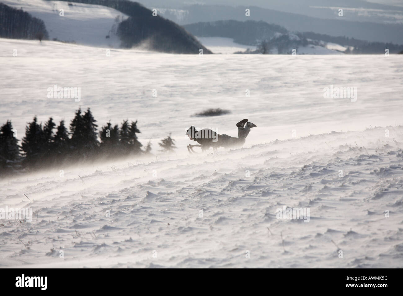 Sledder, blowing snow, Mt. Wasserkruppe, Rhoen Mountains, Hesse ...