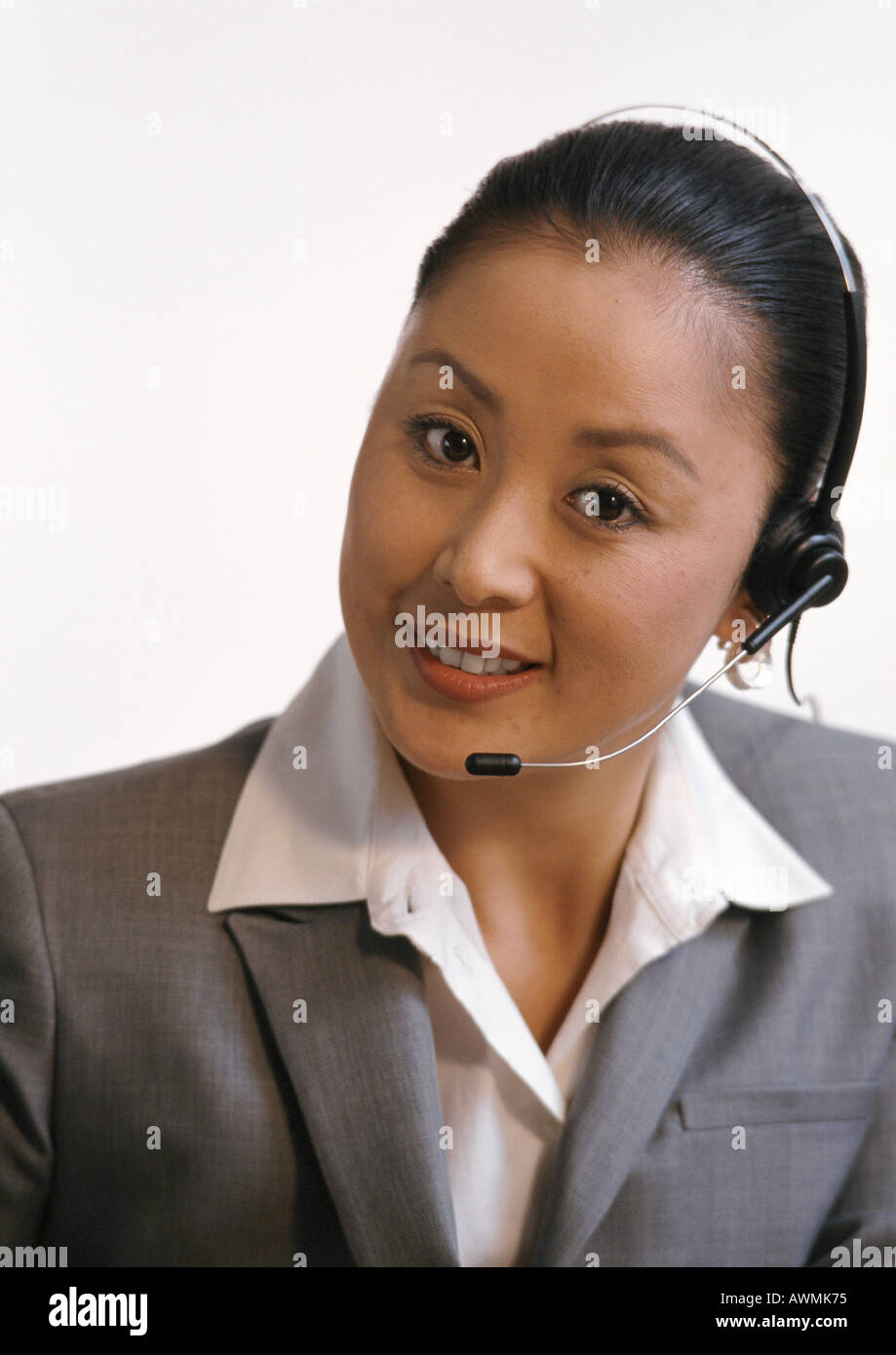 Businesswoman wearing headset, looking at camera, portrait Stock Photo ...