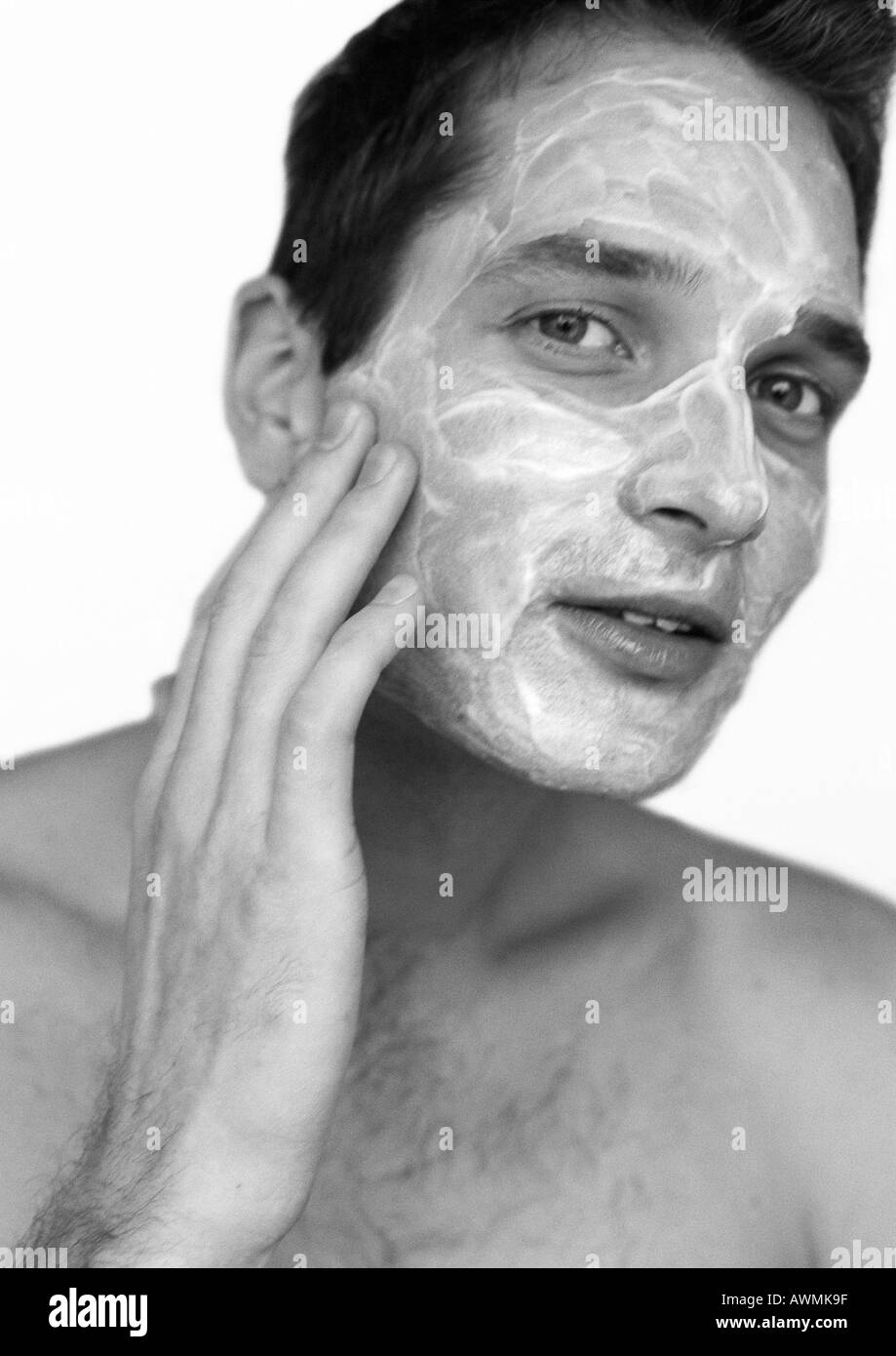 Man putting cream on face, portrait, b&w Stock Photo - Alamy