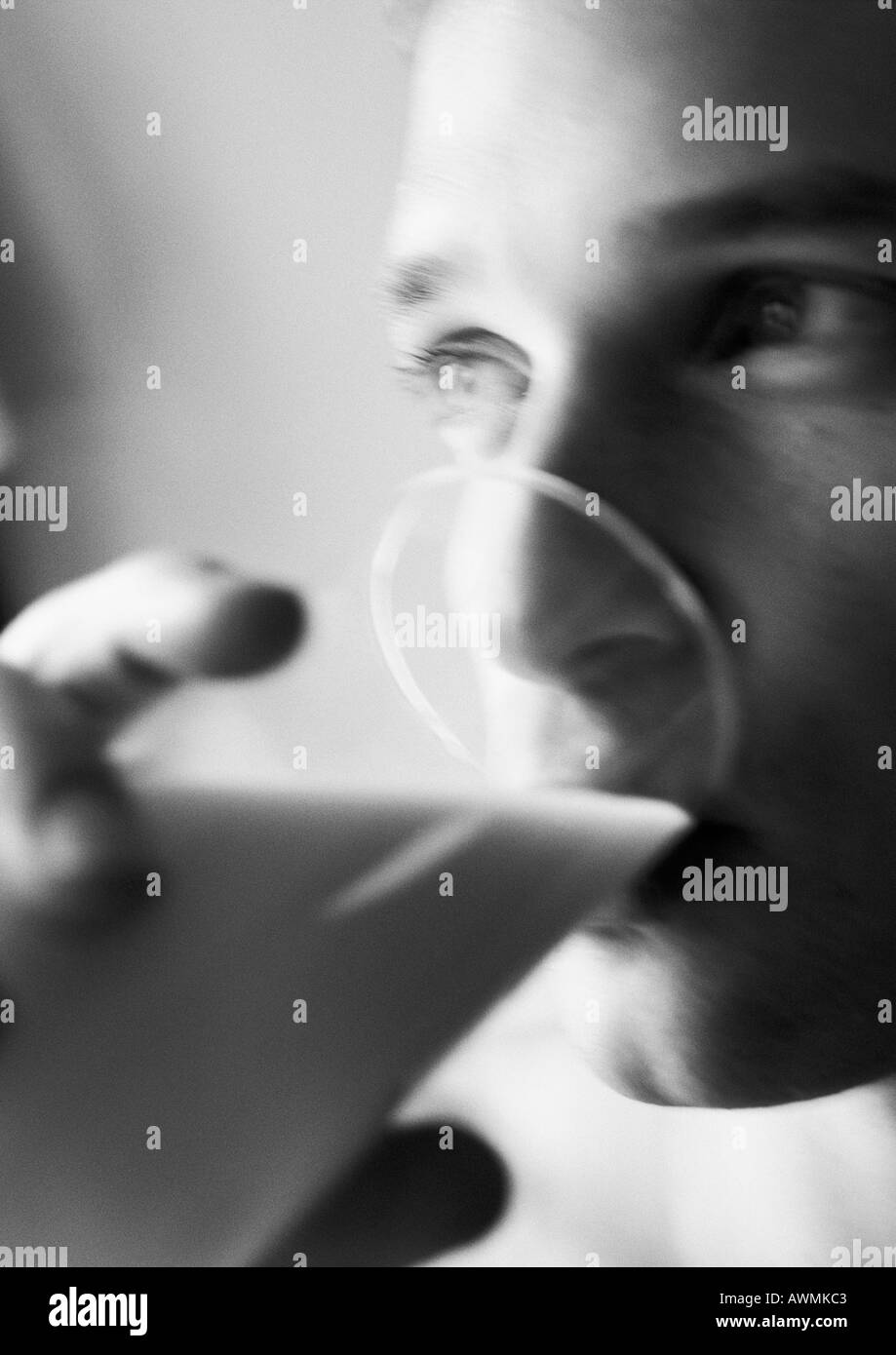 Man drinking from glass, close-up, blurred, b&w Stock Photo - Alamy