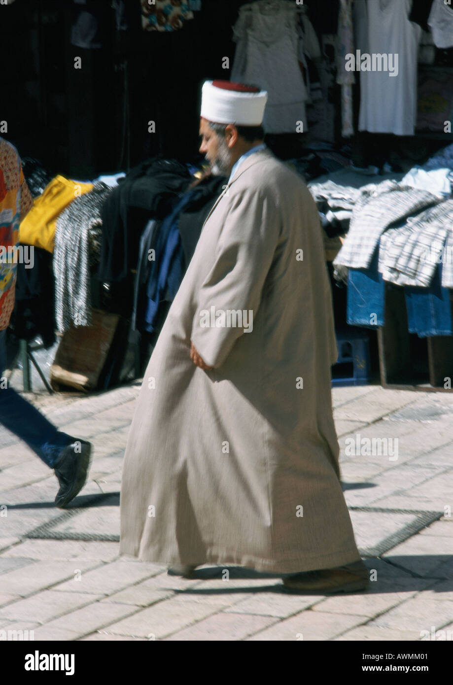Israel, Jerusalem, Muslim man walking in street, side view Stock Photo ...