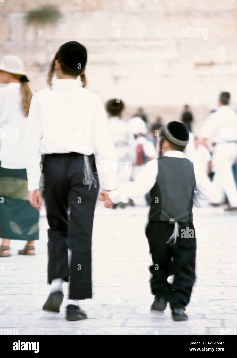 Israel, Jerusalem, two Orthodox Jewish boys wearing kippas and holding ...