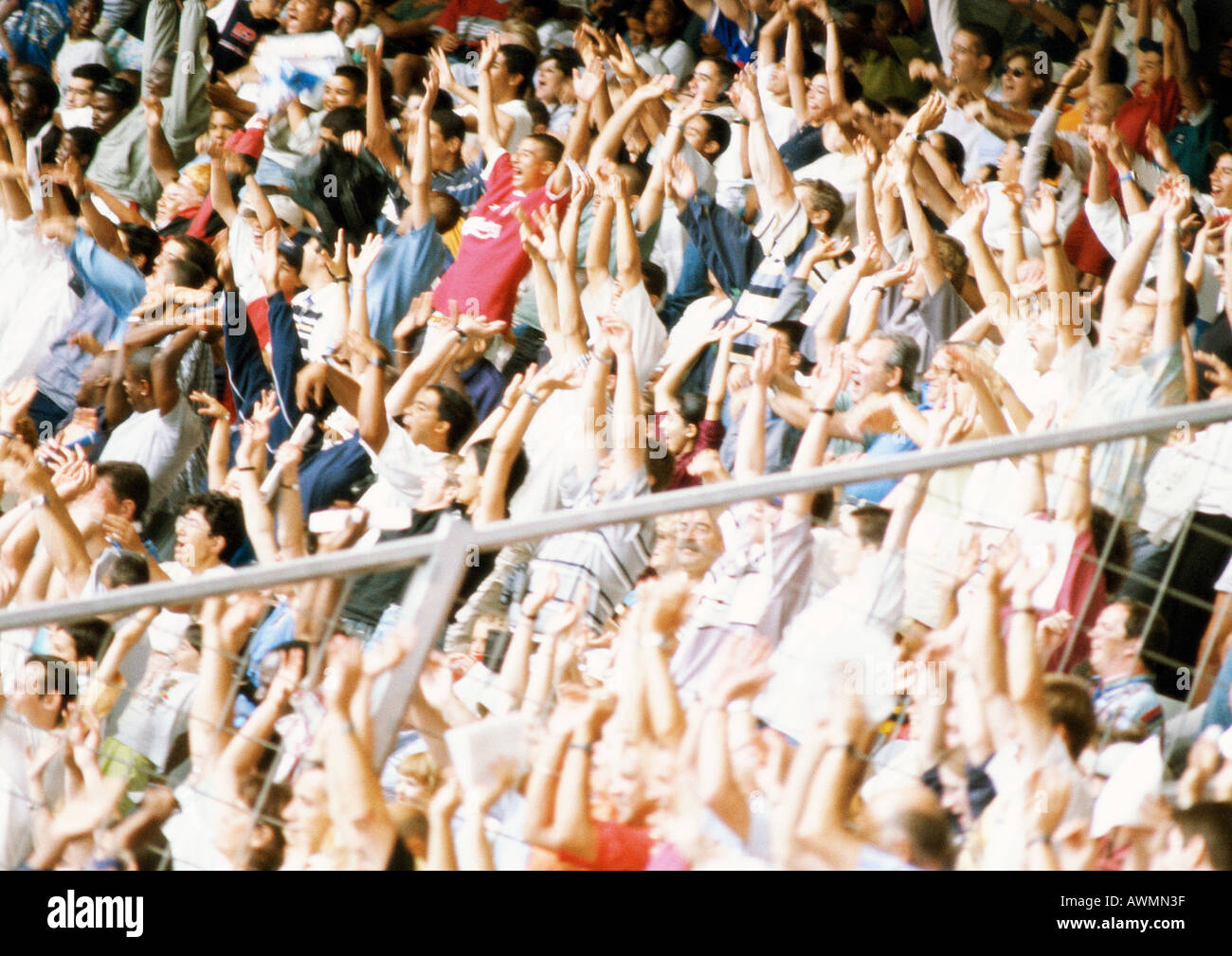 Crowd in stadium with arms in air Stock Photo - Alamy