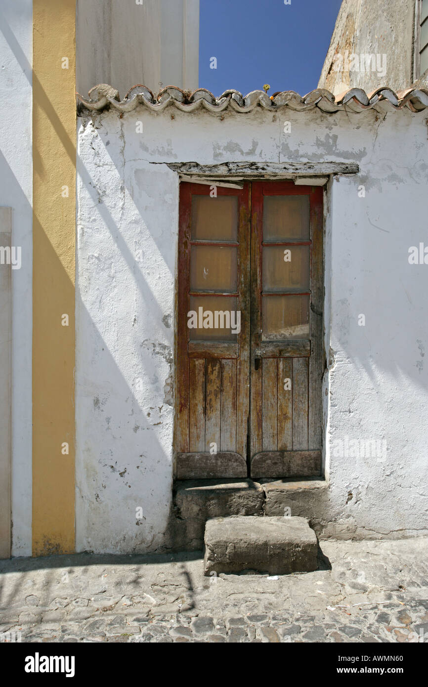 An old rustic door on a white washed house in the coastal village of ...
