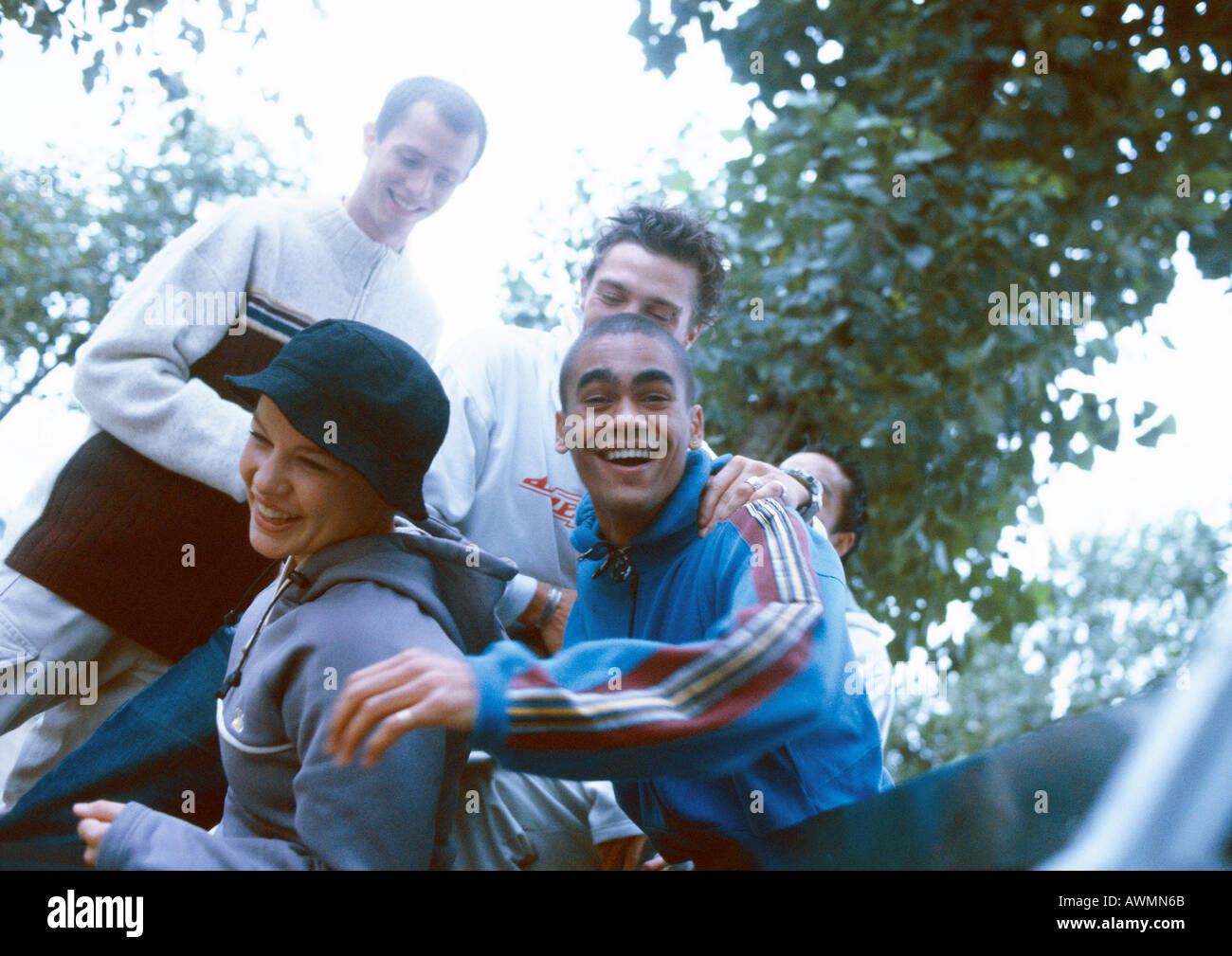 Four young people outside, smiling Stock Photo - Alamy