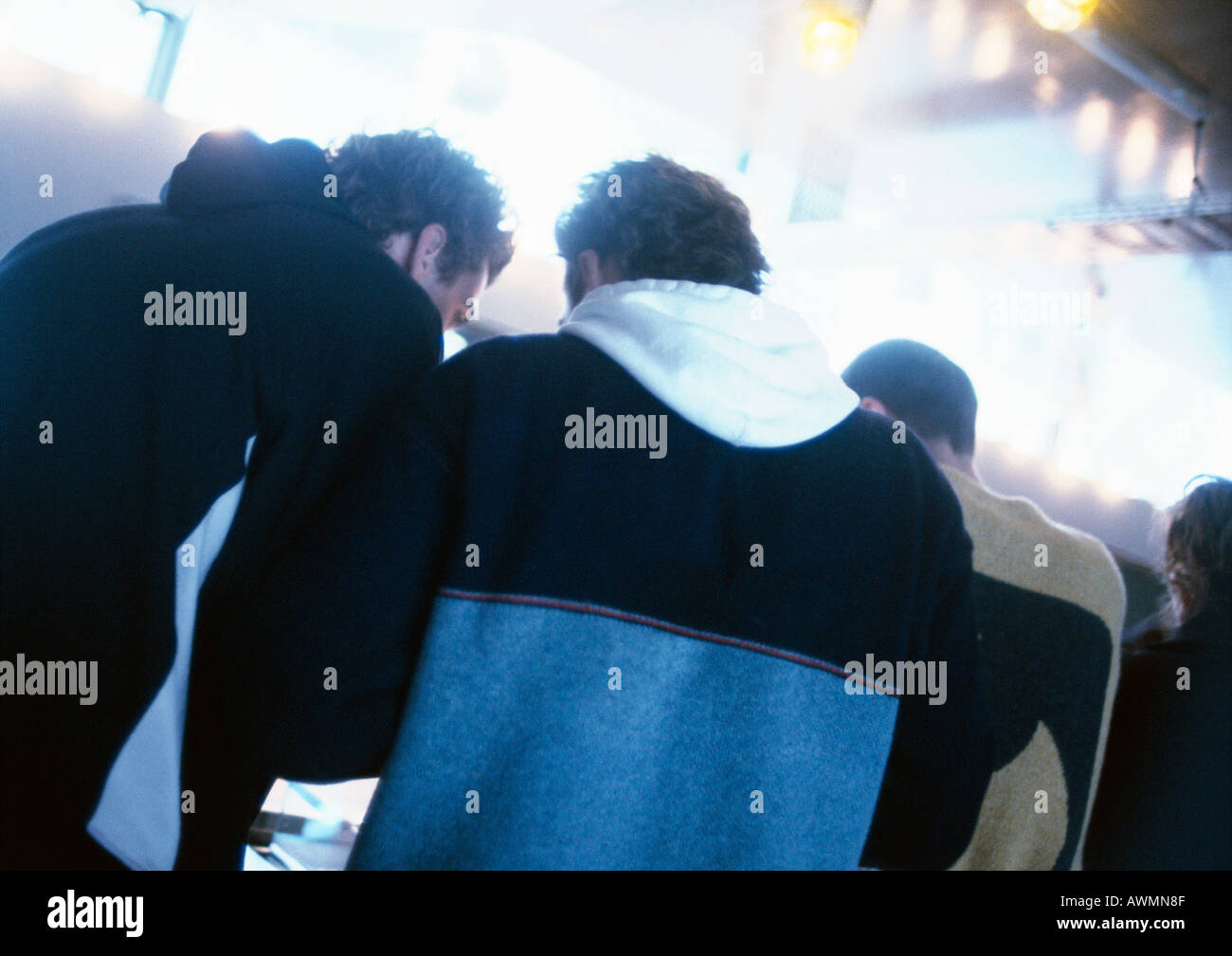 Three men standing side by side, rear view Stock Photo - Alamy