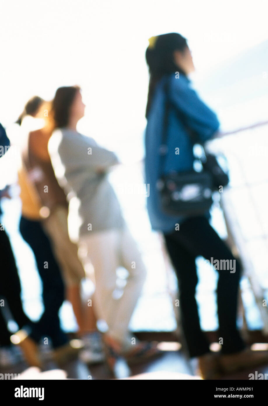 People leaning against railing, blurred Stock Photo - Alamy