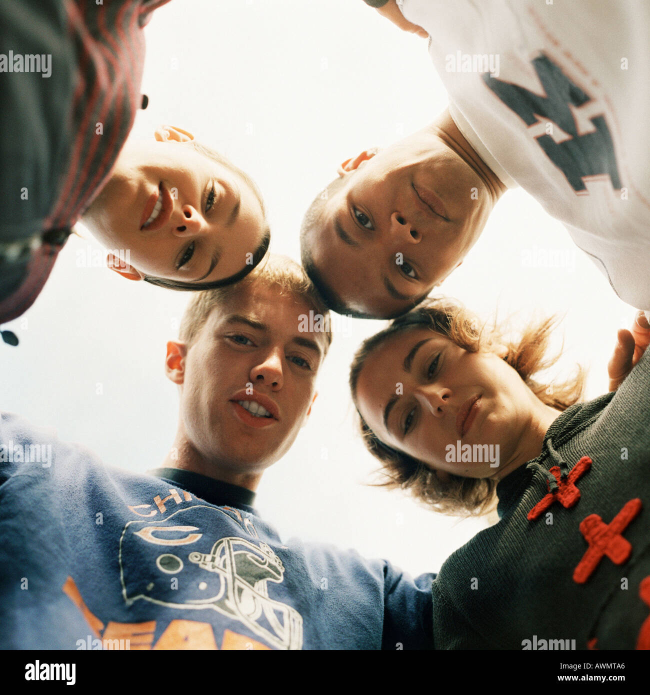 Low angle view of four diverse business executives looking down into ...