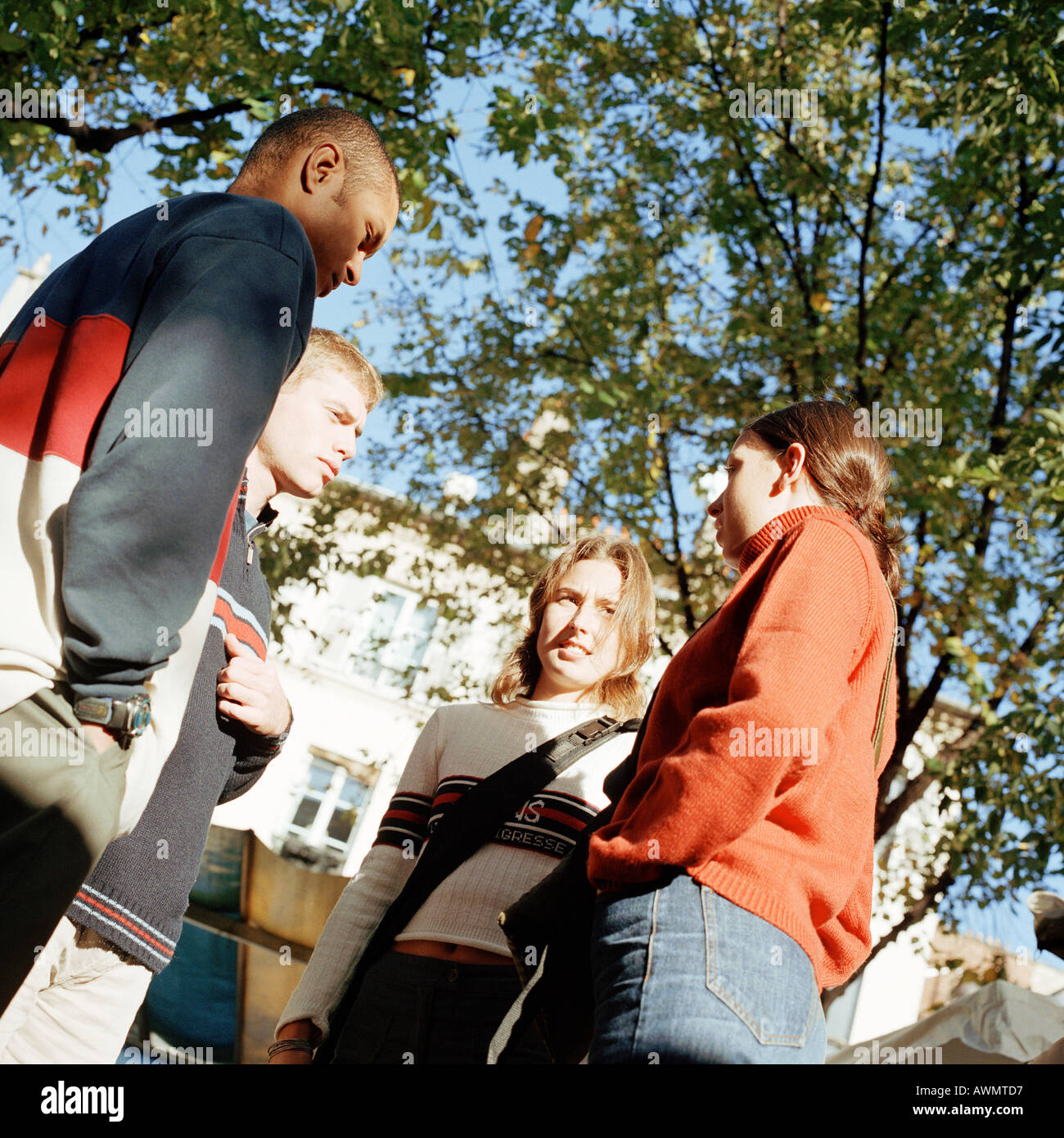 Young people talking together outside, low angle view Stock Photo - Alamy