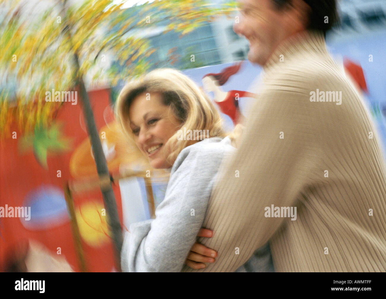 Man holding woman from behind, side view, motion, blurred Stock Photo ...