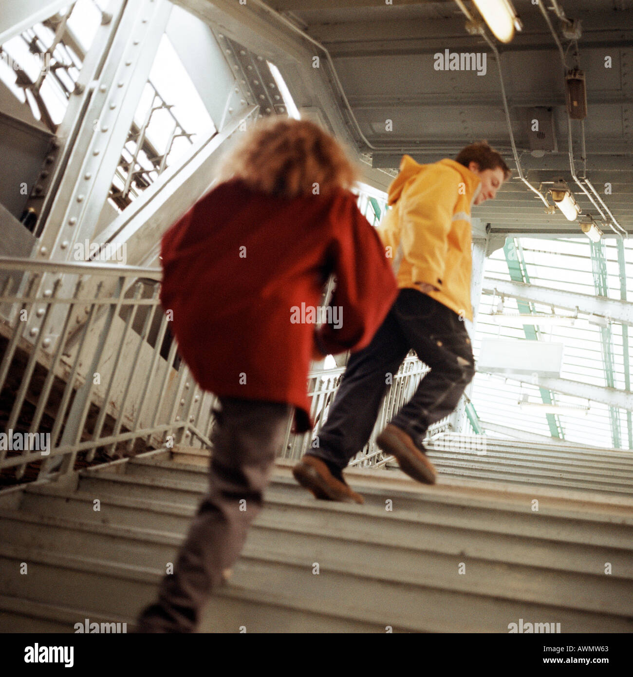 Young people walking up stairs in elevated subway station Stock Photo ...