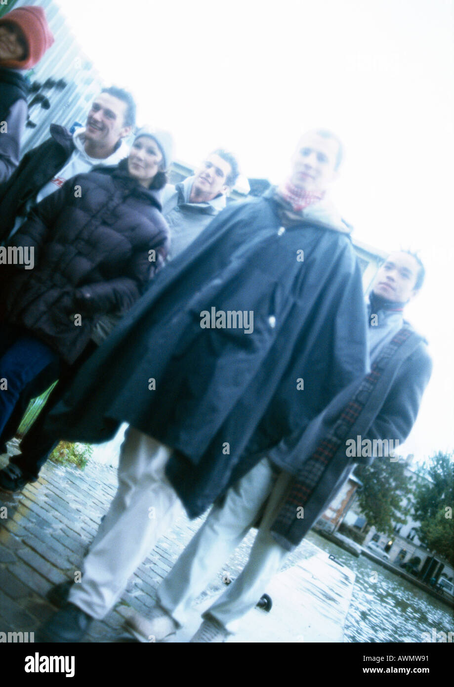 Group of young people on sidewalk, tilt Stock Photo - Alamy