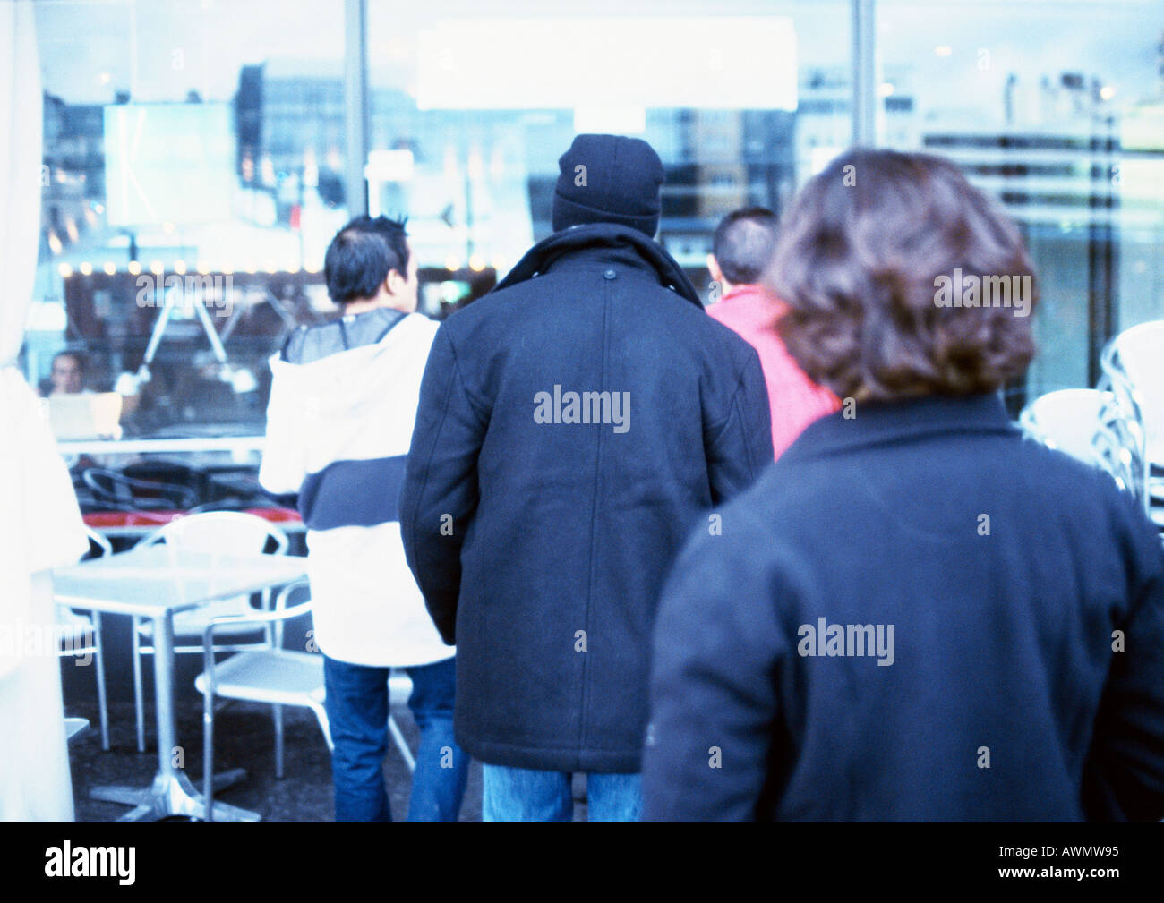 Group of young people outside cafe, rear view Stock Photo - Alamy