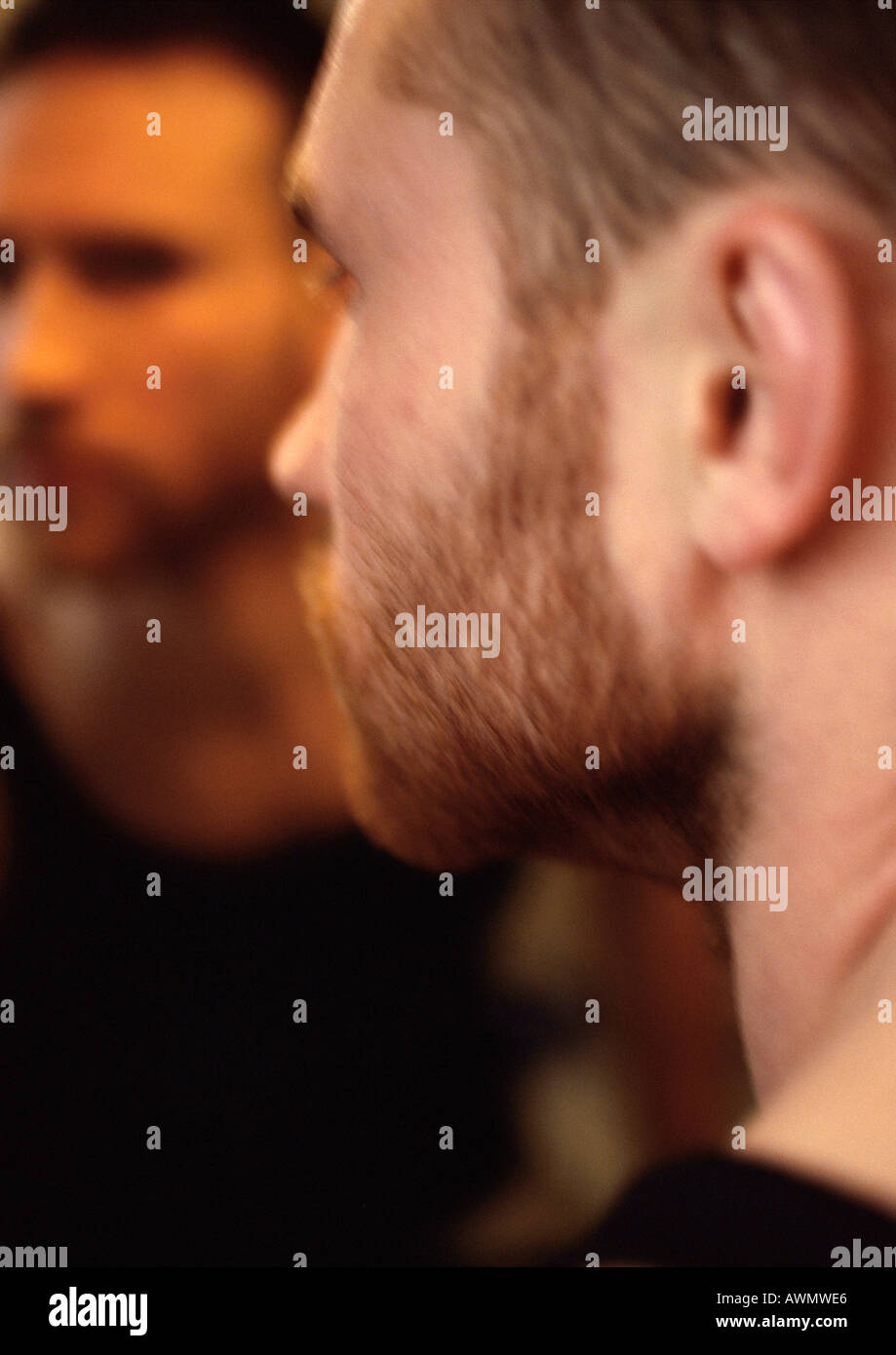 Man's face, view from over the shoulder, man's reflection in mirror in ...