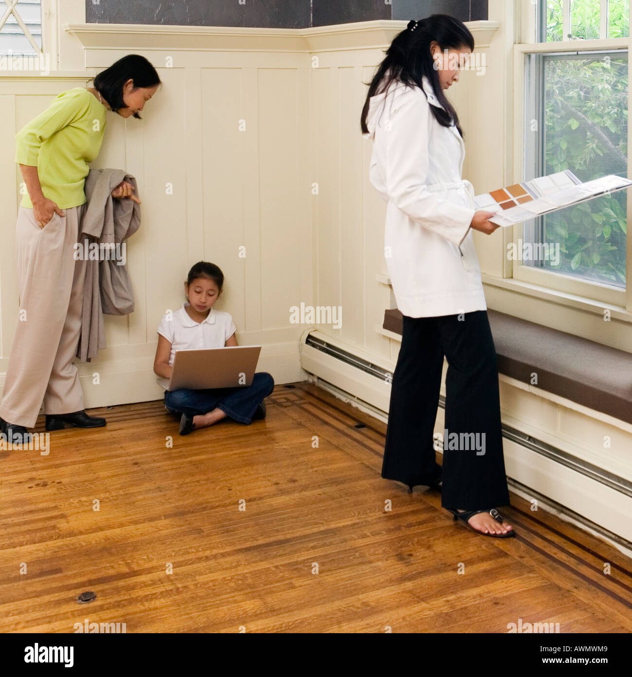 Asian woman looking at textile swatches Stock Photo - Alamy