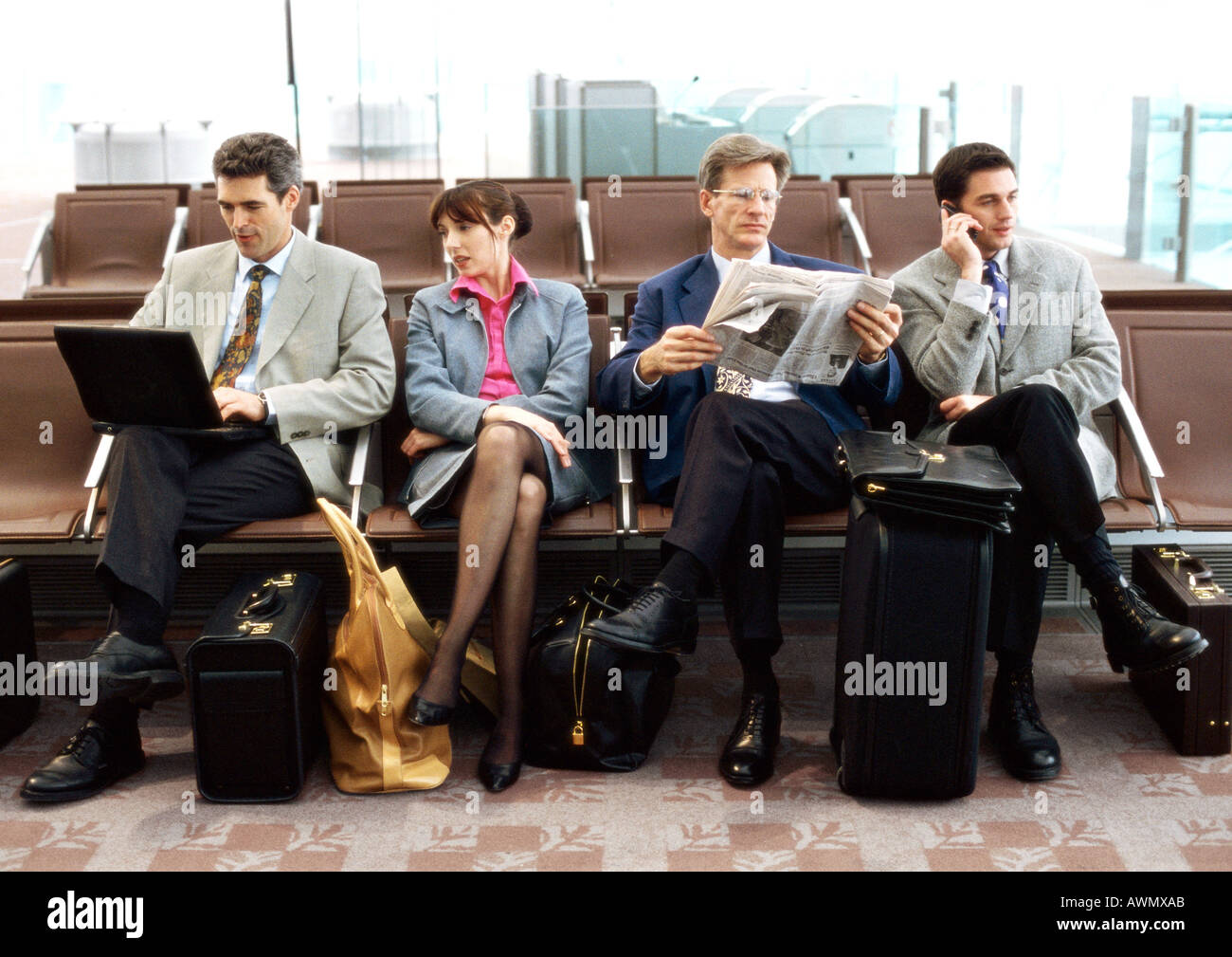 Group of business people sitting in terminal Stock Photo - Alamy
