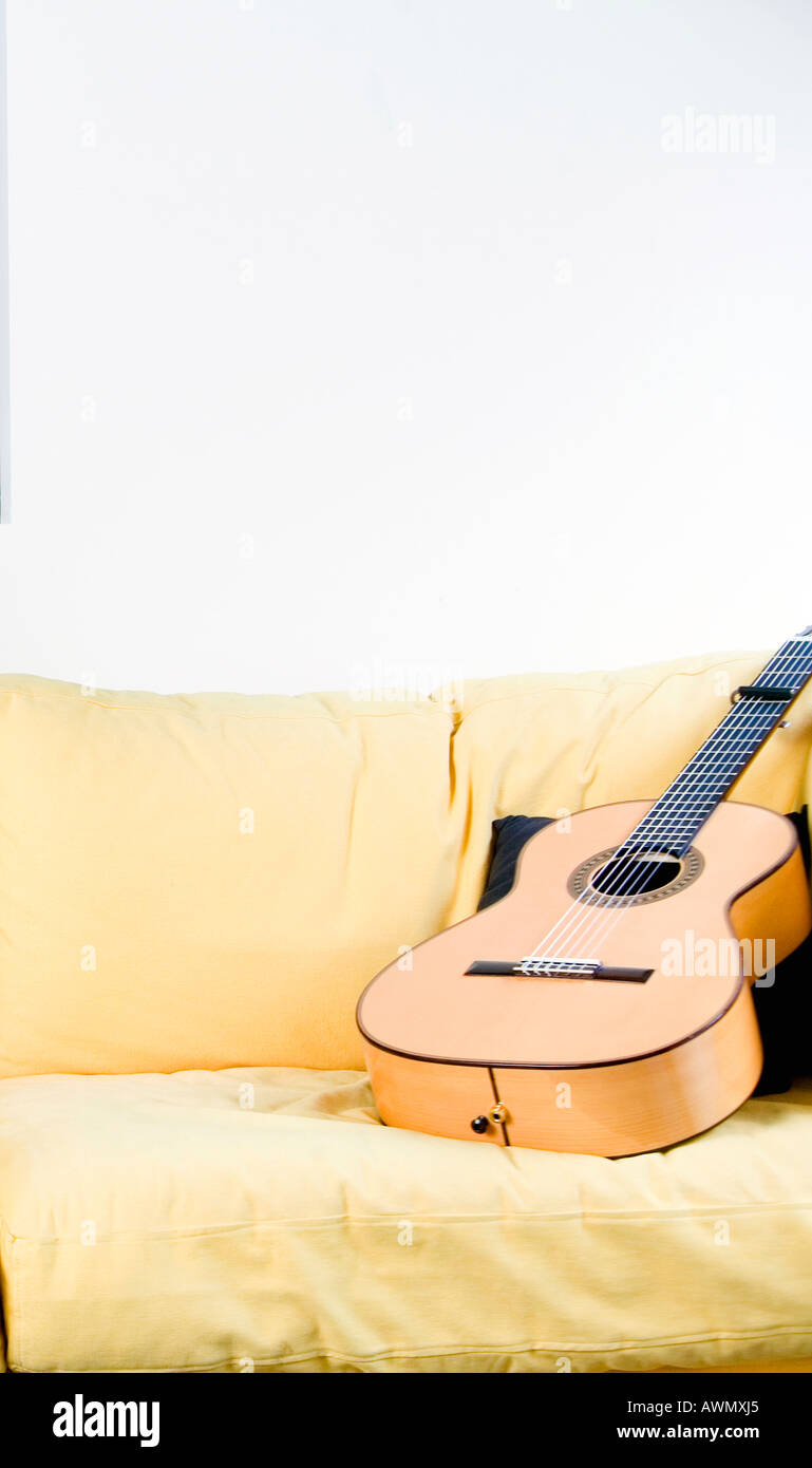 Acoustic guitar on sofa Stock Photo - Alamy