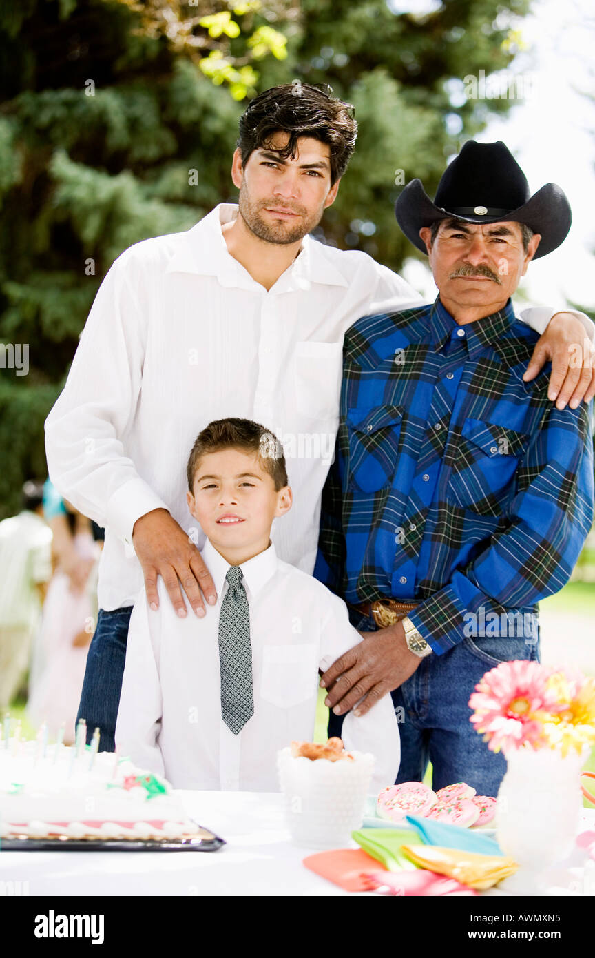 Hispanic grandfather, father and son hugging Stock Photo - Alamy