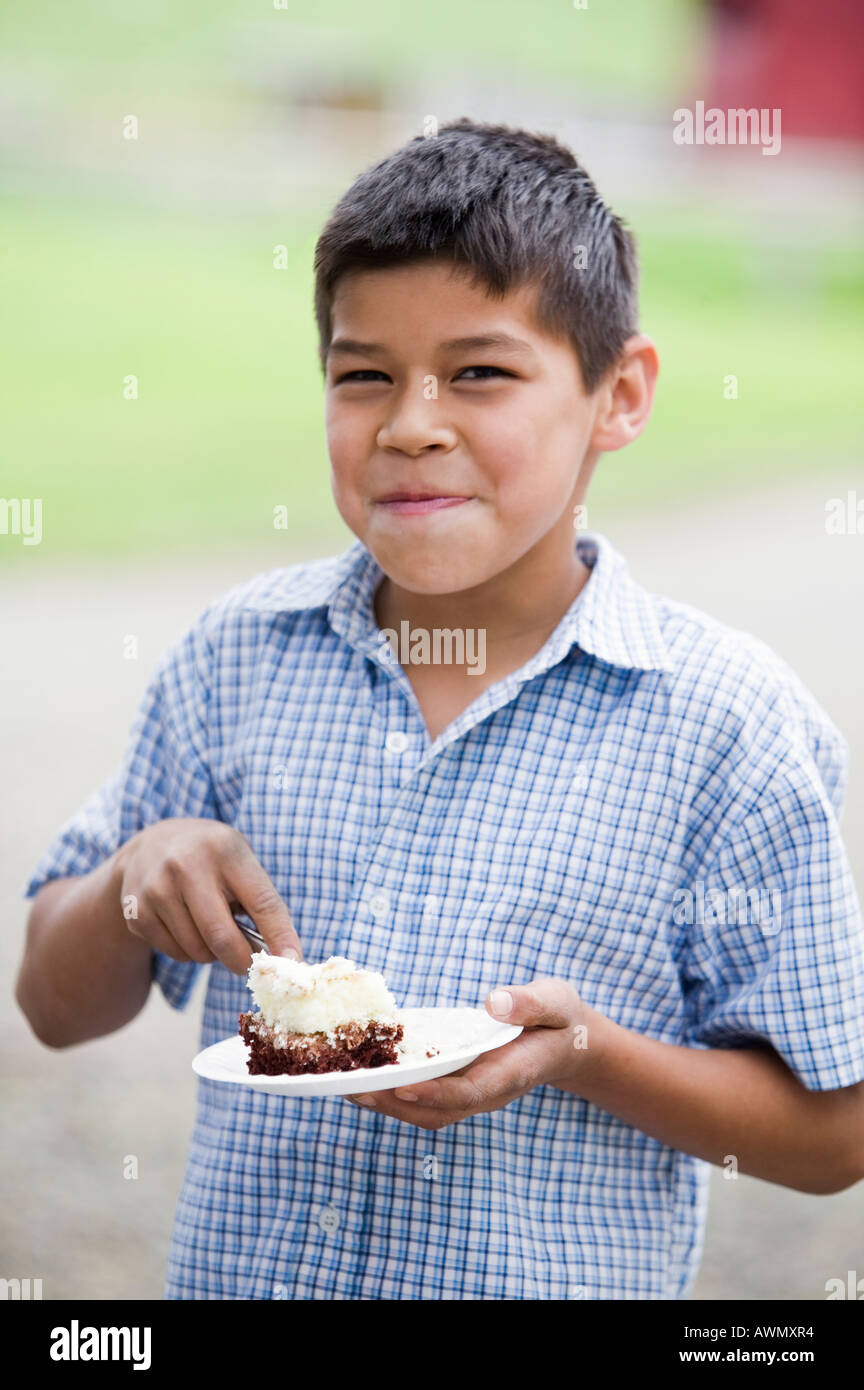 Hispanic boy eating cake Stock Photo - Alamy