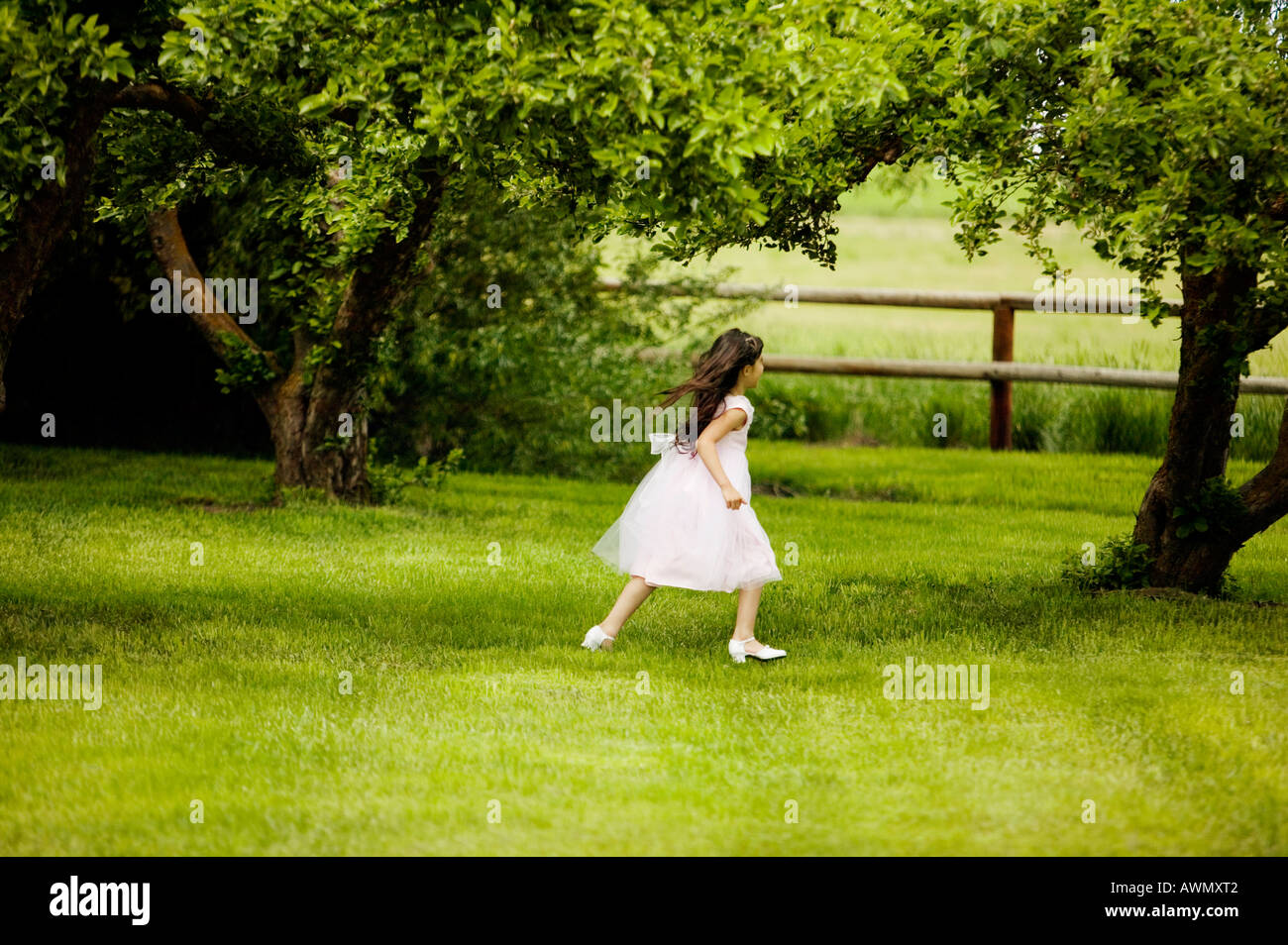 Girl running in party dress Stock Photo - Alamy