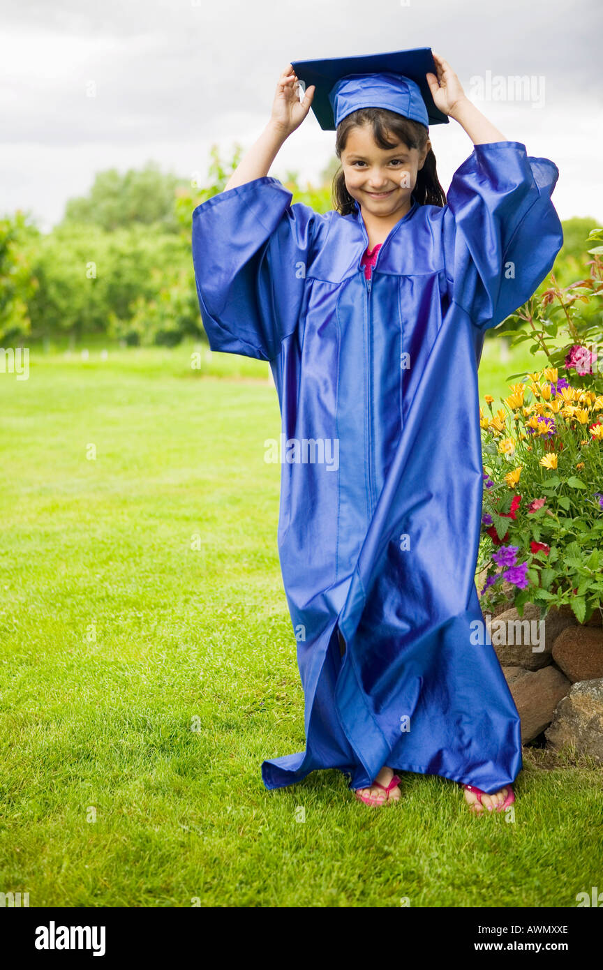 Hispanic girl wearing graduation cap and gown Stock Photo - Alamy