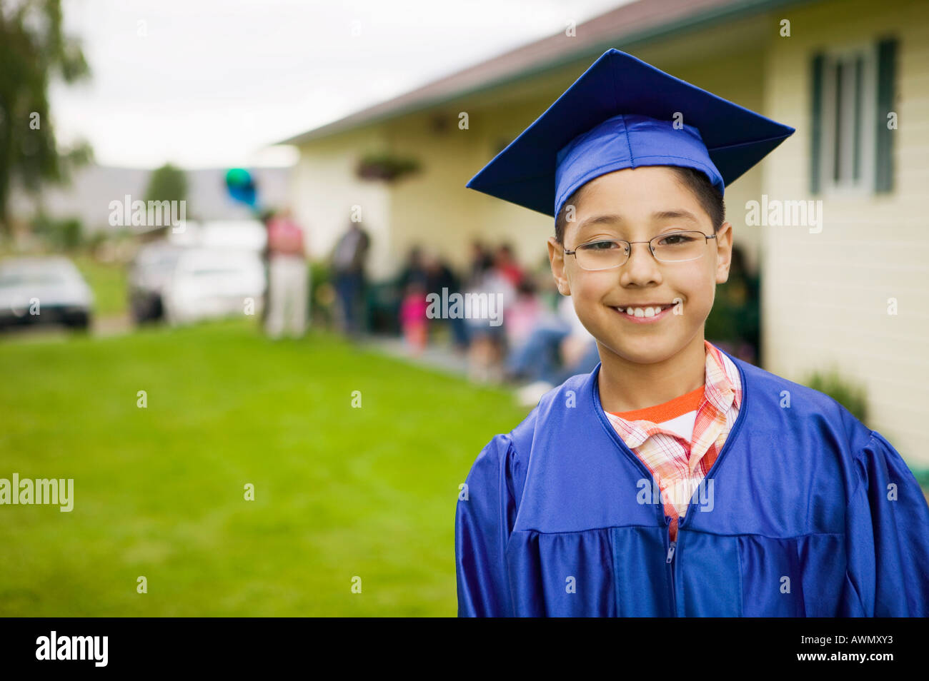 Hispanic boy wearing graduation cap and gown Stock Photo - Alamy