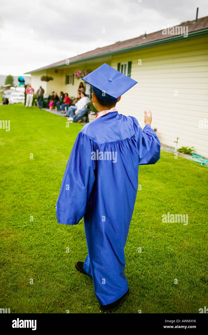 Boy wearing graduation cap and gown Stock Photo - Alamy
