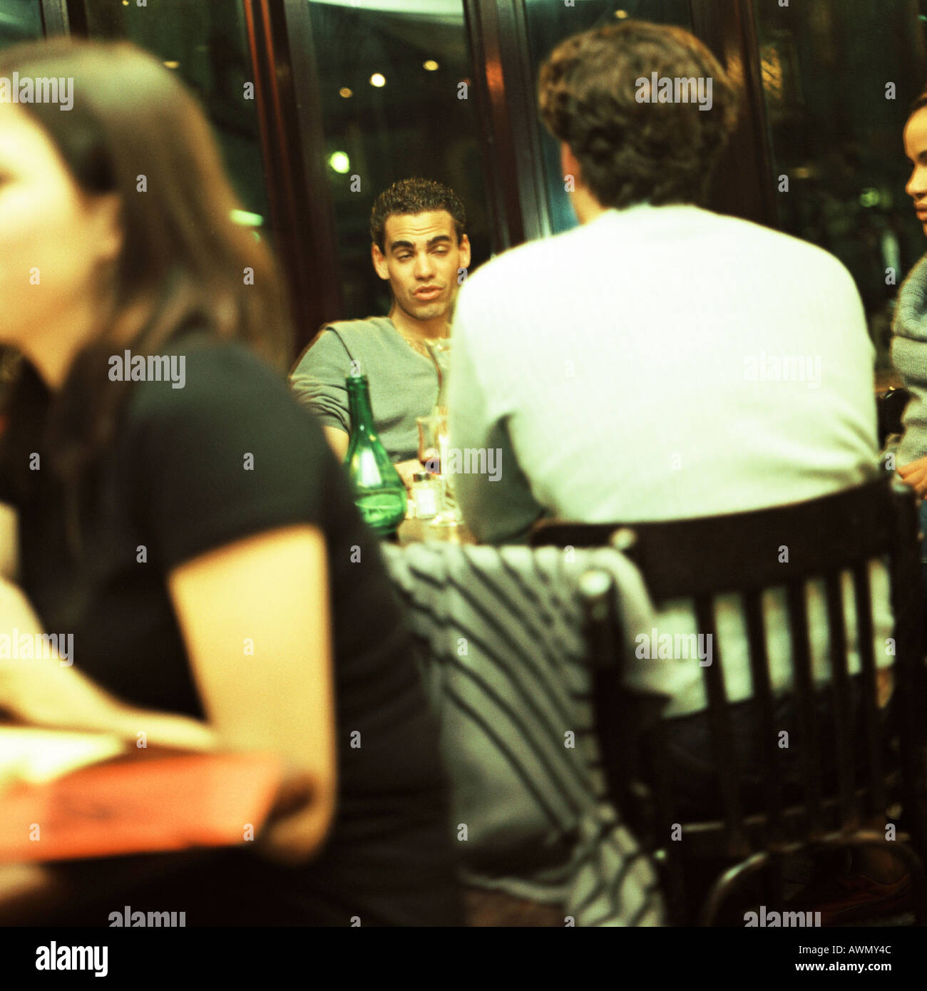 Young people sitting in bar Stock Photo - Alamy